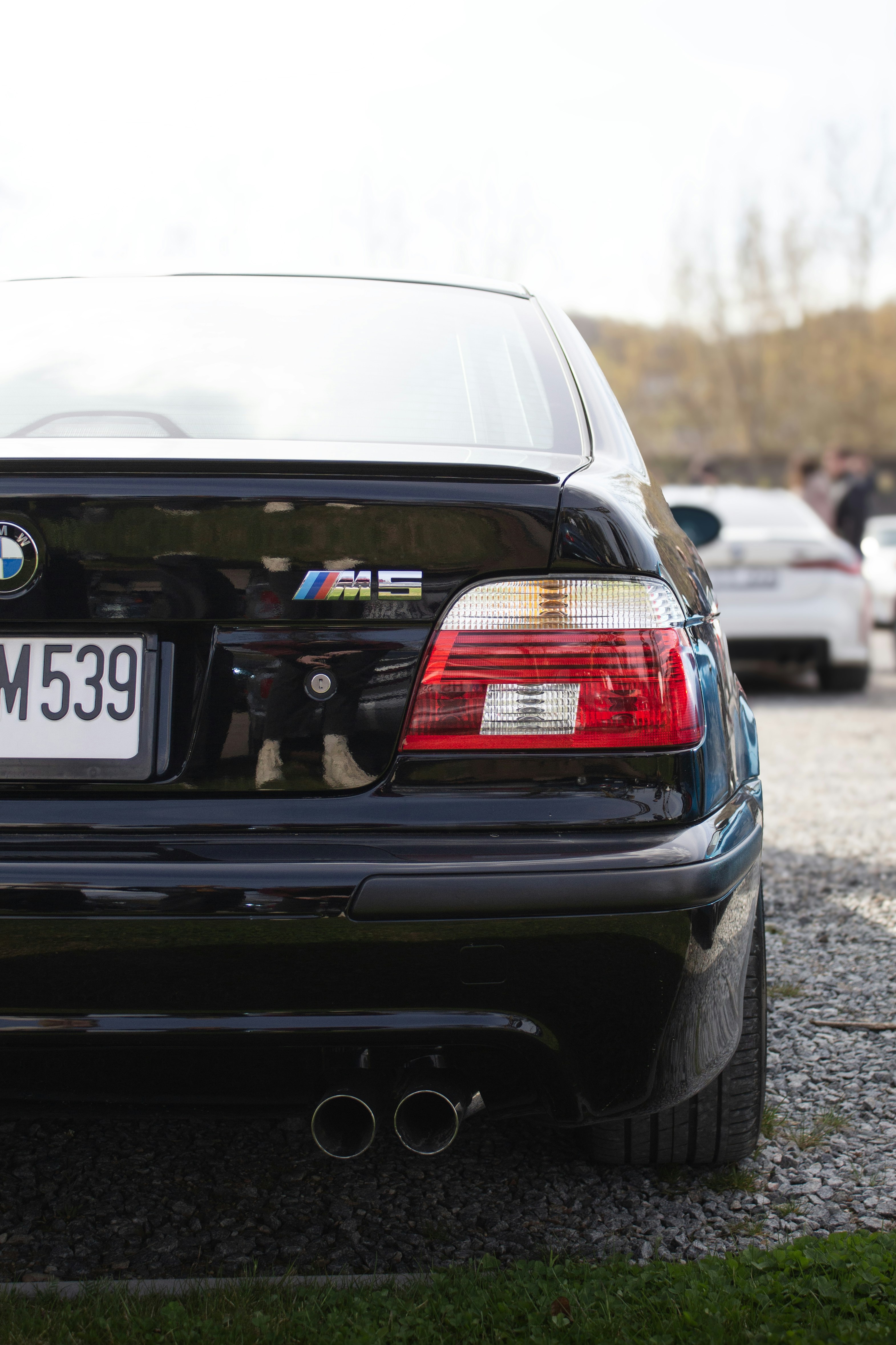 Rear Badge Reflections: A BMW M5 Sunset in a Parking Lot