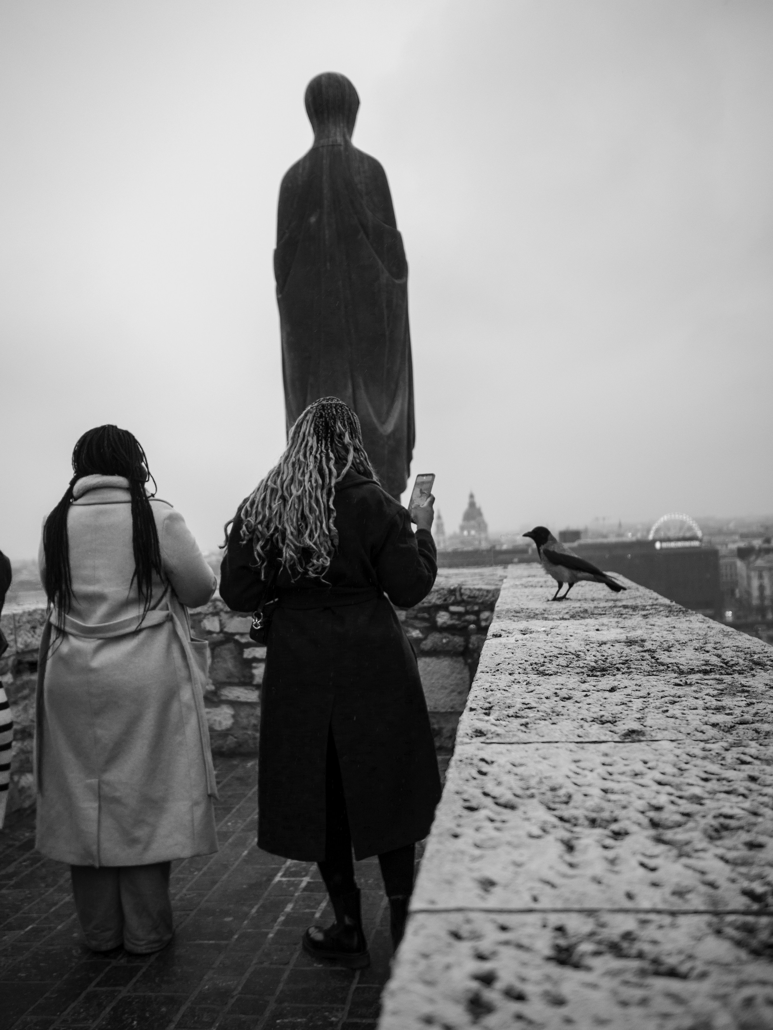 Statues, Seabird, and Shadow: A Quiet Vantage Point in Dusk Over Prague