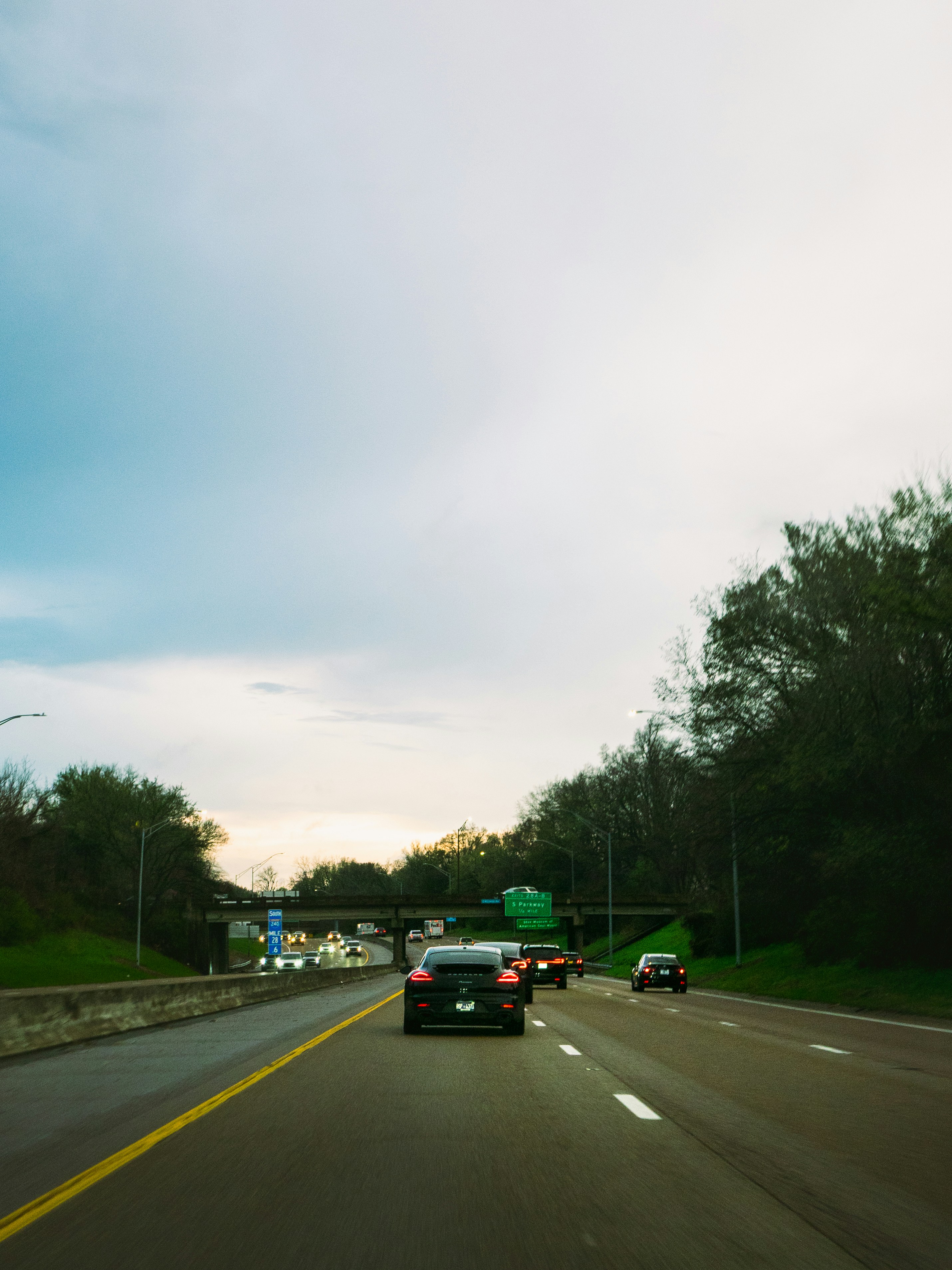 Cars in the Slow Lane Under a Wide Sky