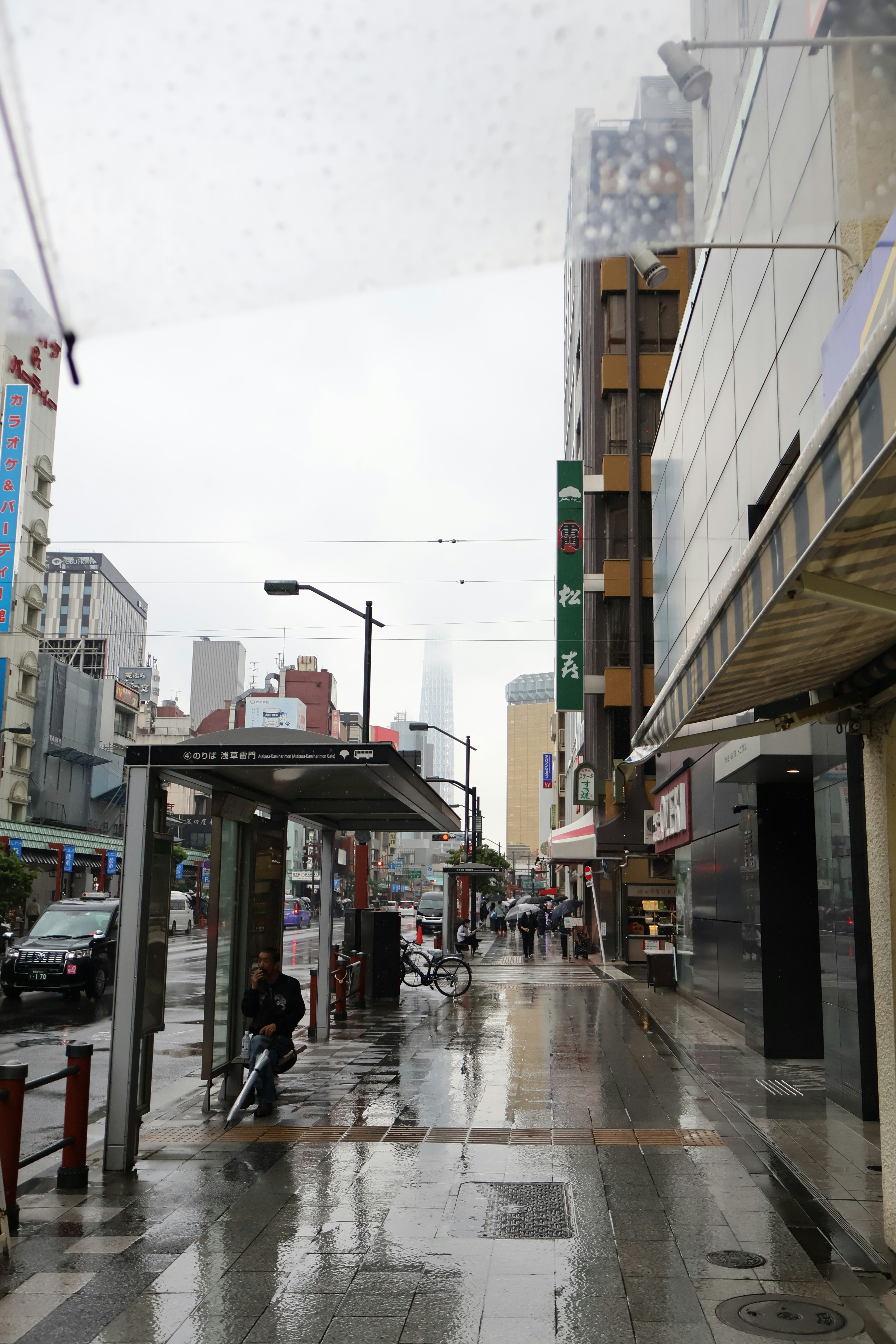 Rain-Slicked City Walk: Neon Signs and a Shimmering Street