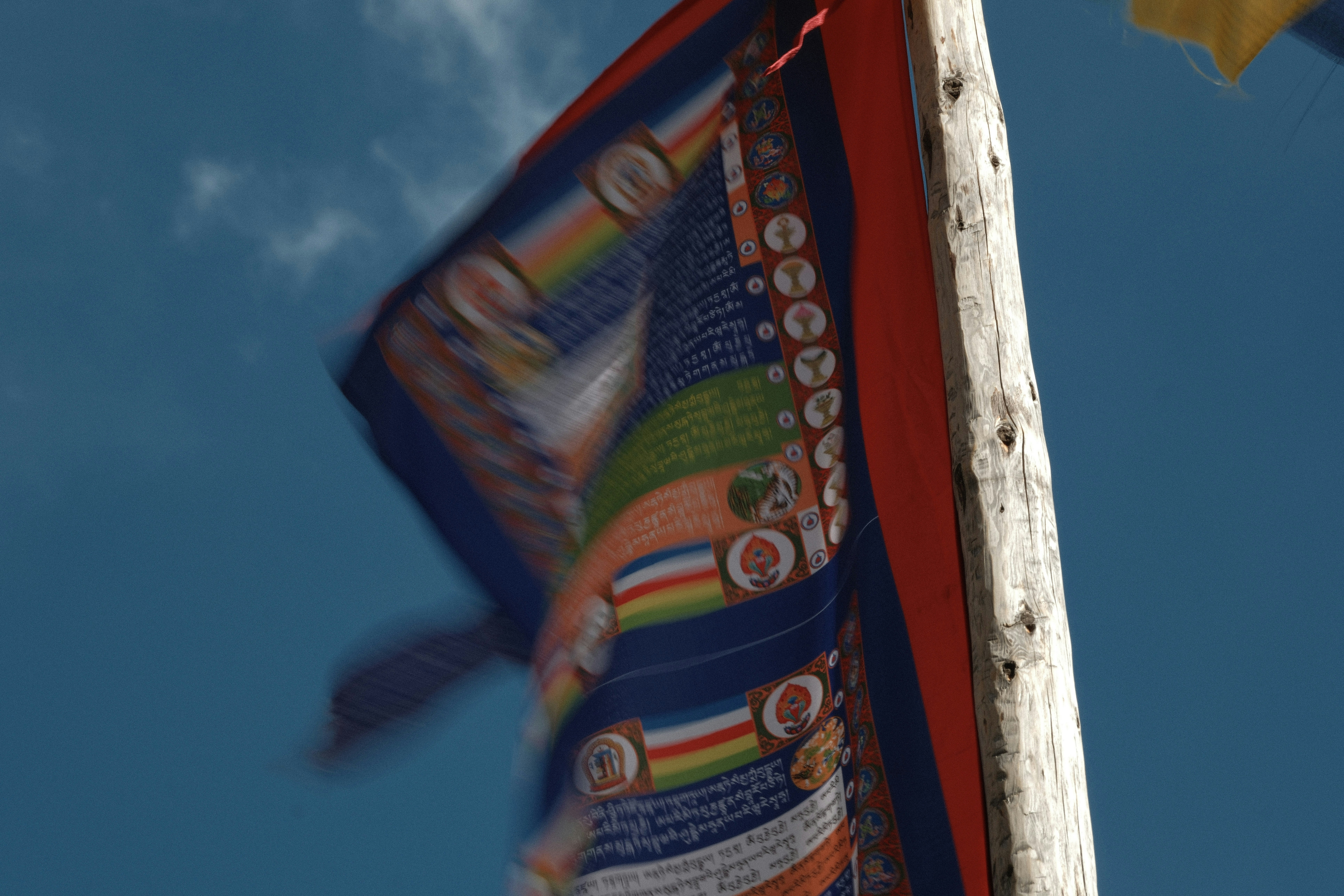 Vibrant Flag in Motion Under Clear Sky
