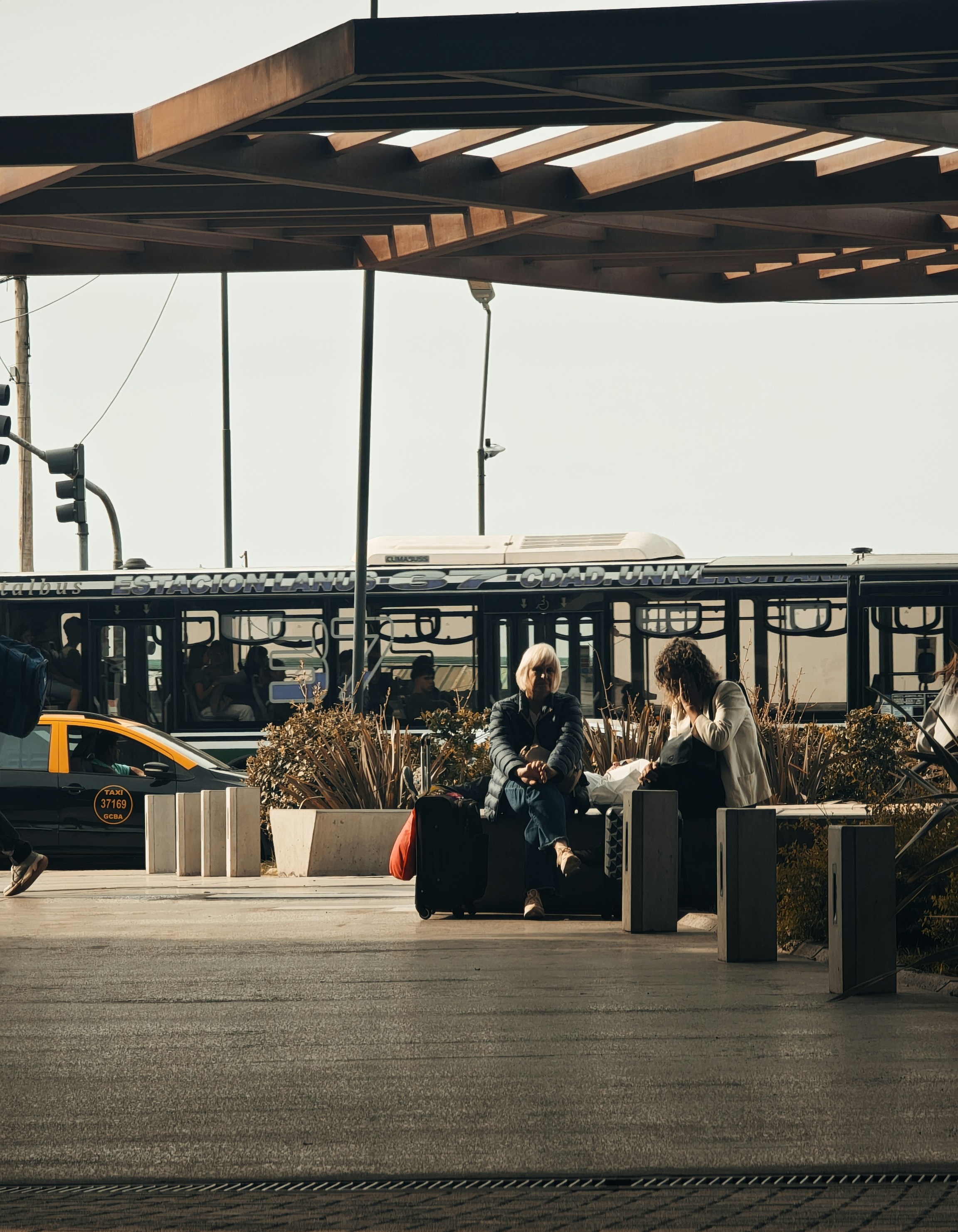 Quiet Exchange at the Bus Shelter