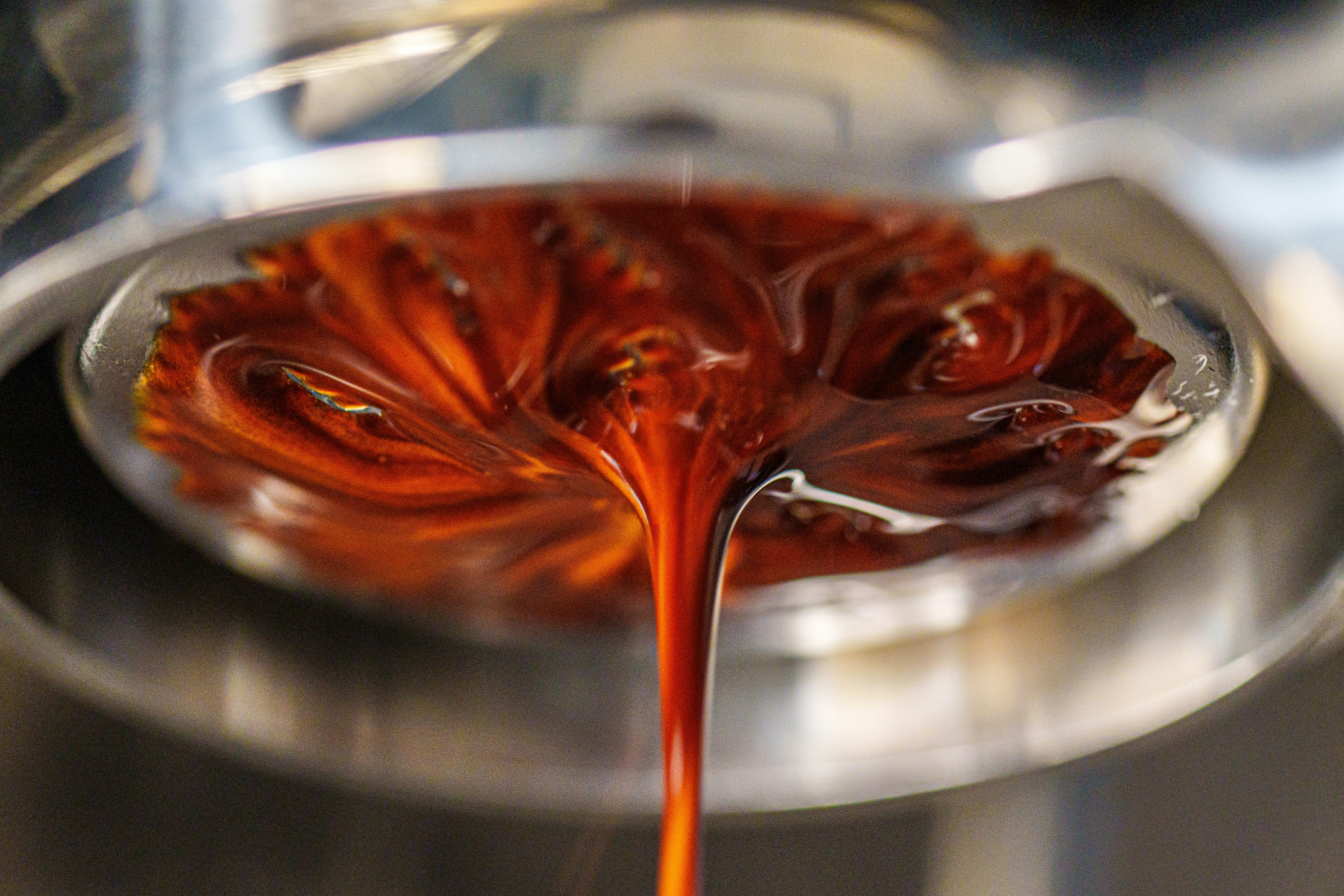 Suspended Ribbon: Dark Caramel Pour from a Glass Ring