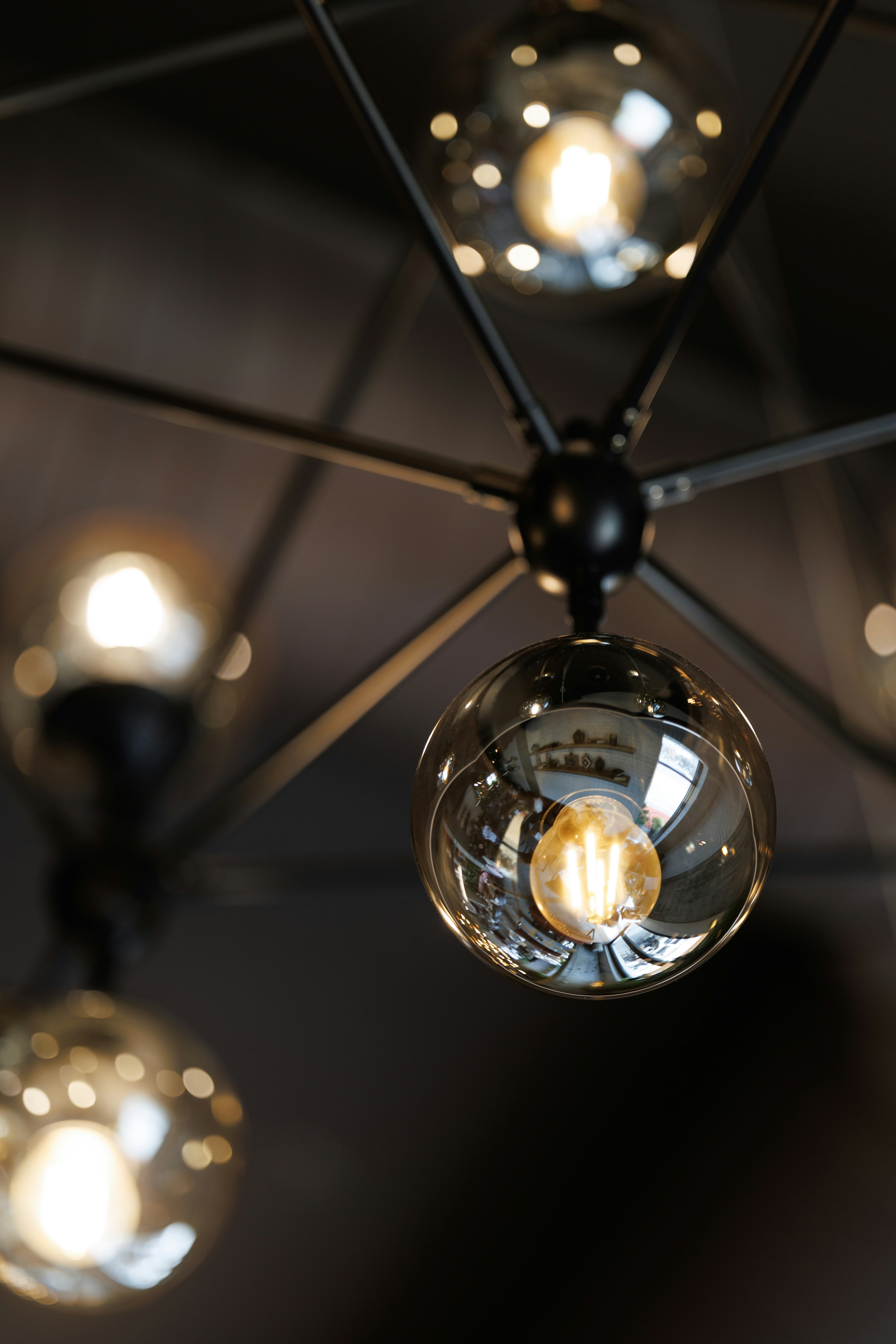 Reflective Globe: A Spark of Light Amid Geometric Orbits