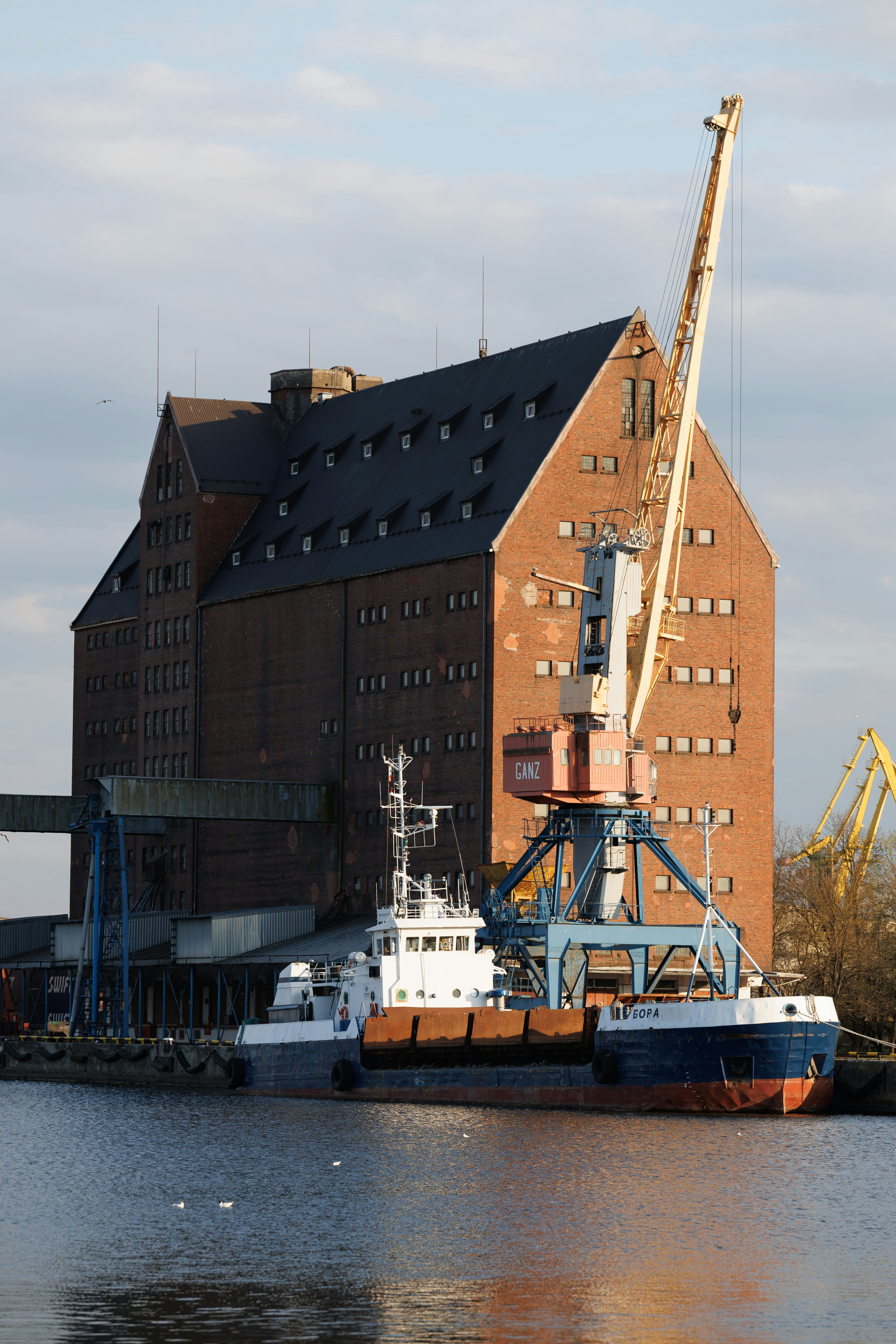 Harbor Crane and Brick Warehouse: A Quiet Industrial Portrait