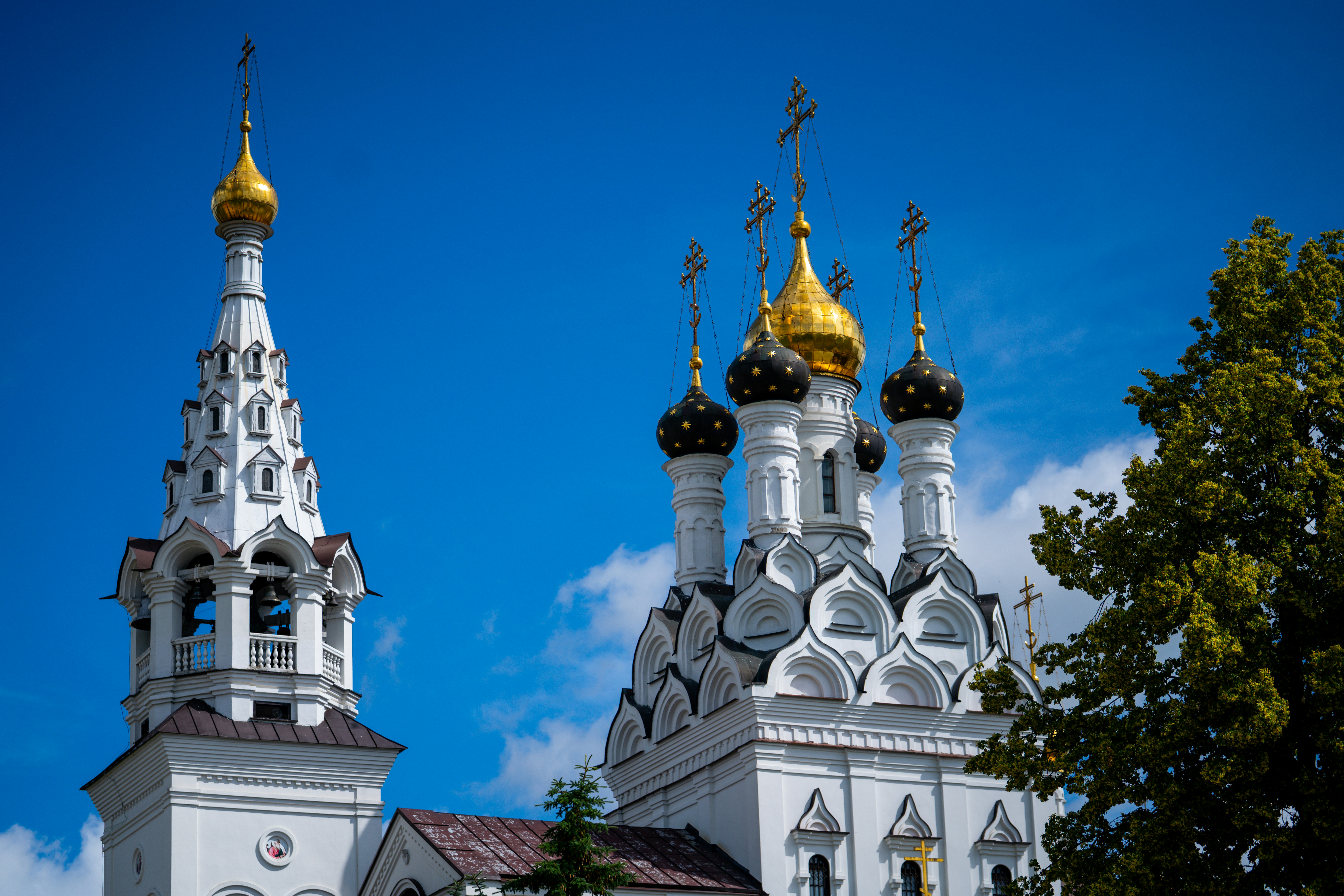 Golden domes and white arches under a cobalt sky