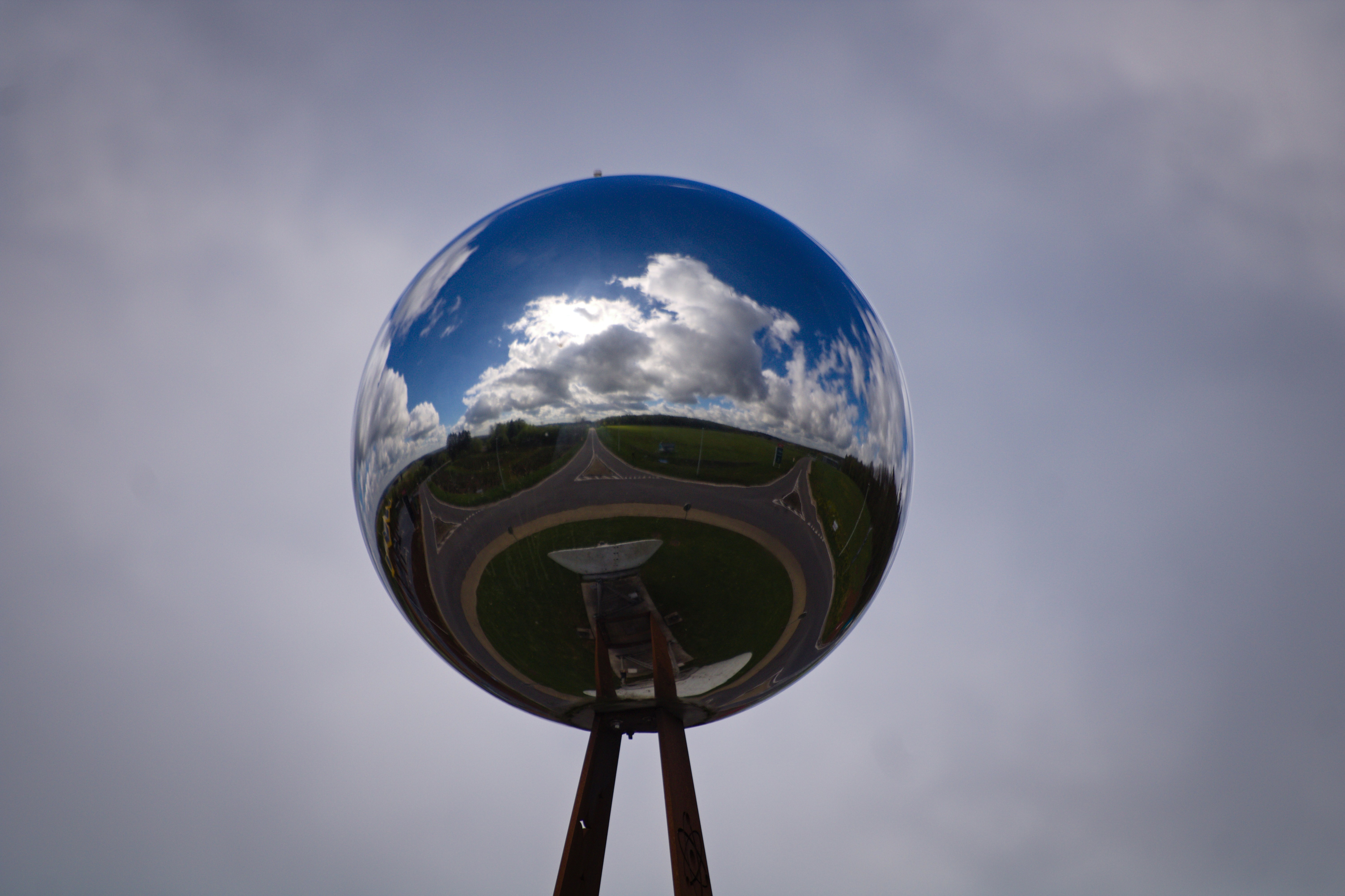 Reflected Globe: A Skyward Sphere Capturing a Park's Echo