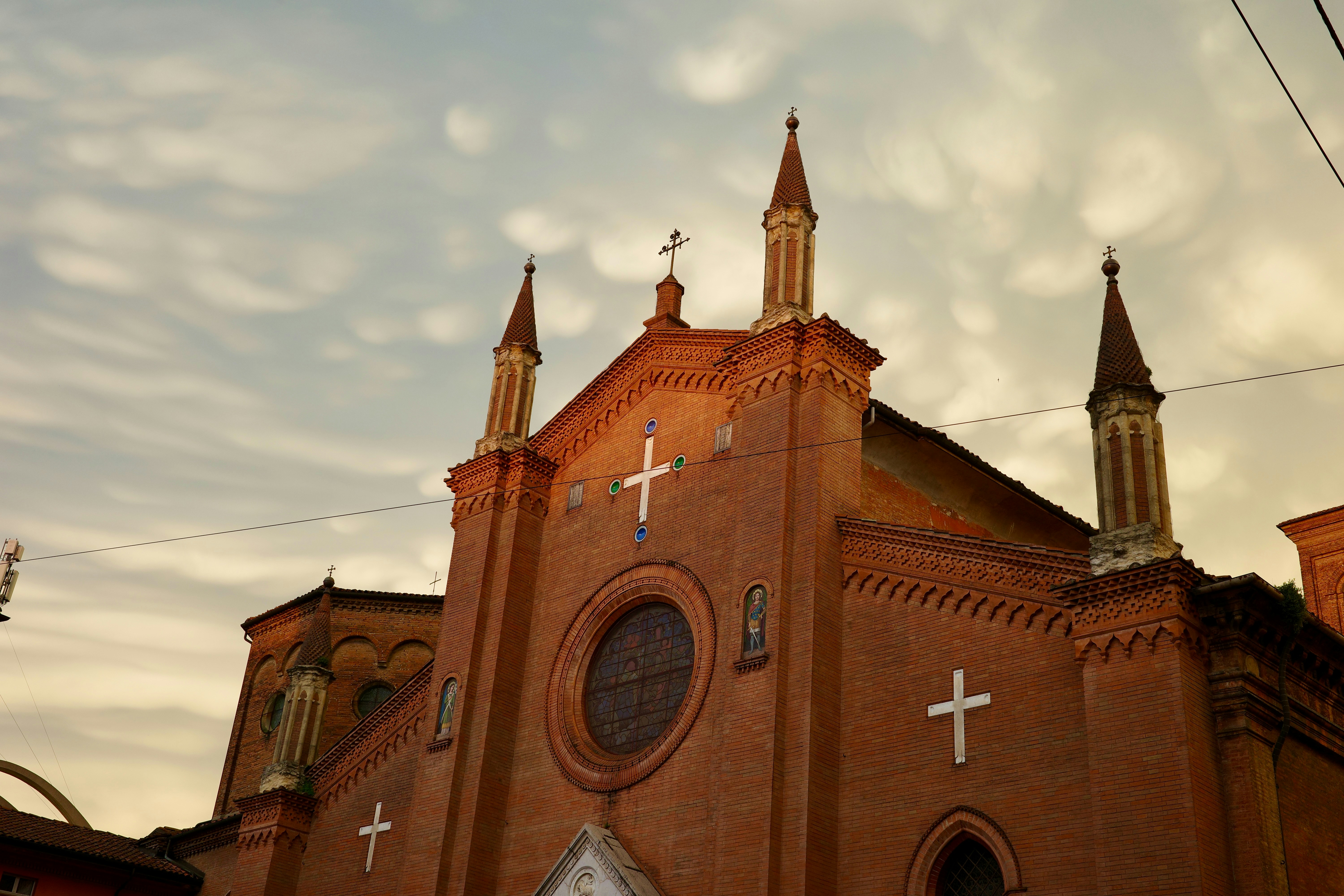 Brick Cathedral Rising: A Christ-centered Facade Under Quiet Skies