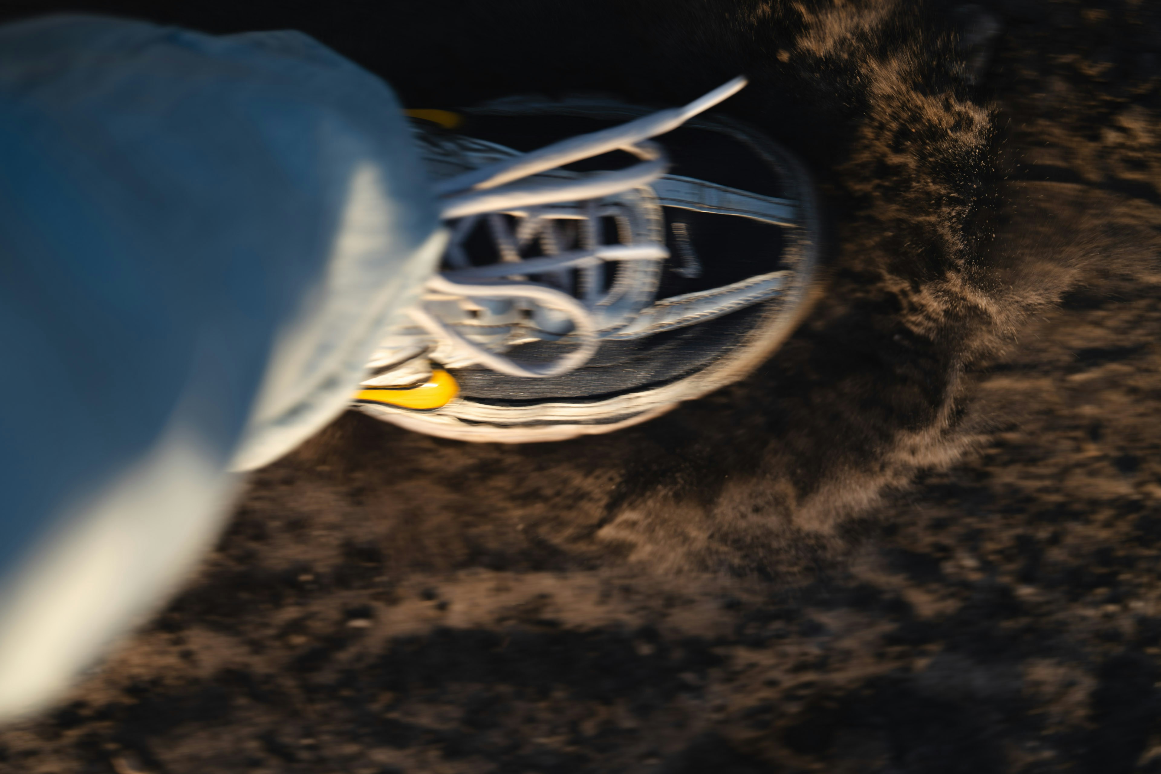 Blurred Descent: A Climber’s Foot Meets the Dirt