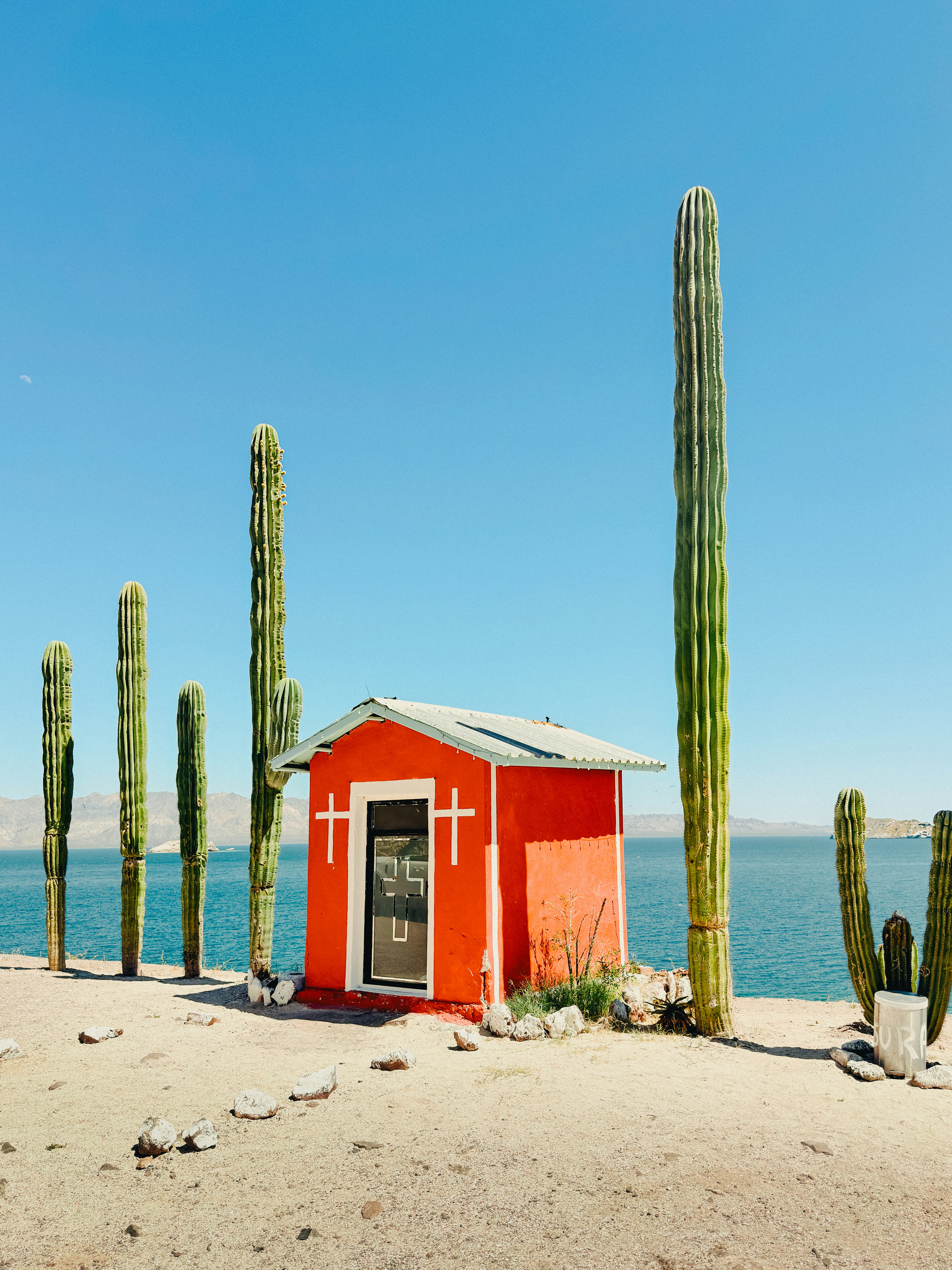 Desert Red Hut by the Sea under a Clear Blue Sky