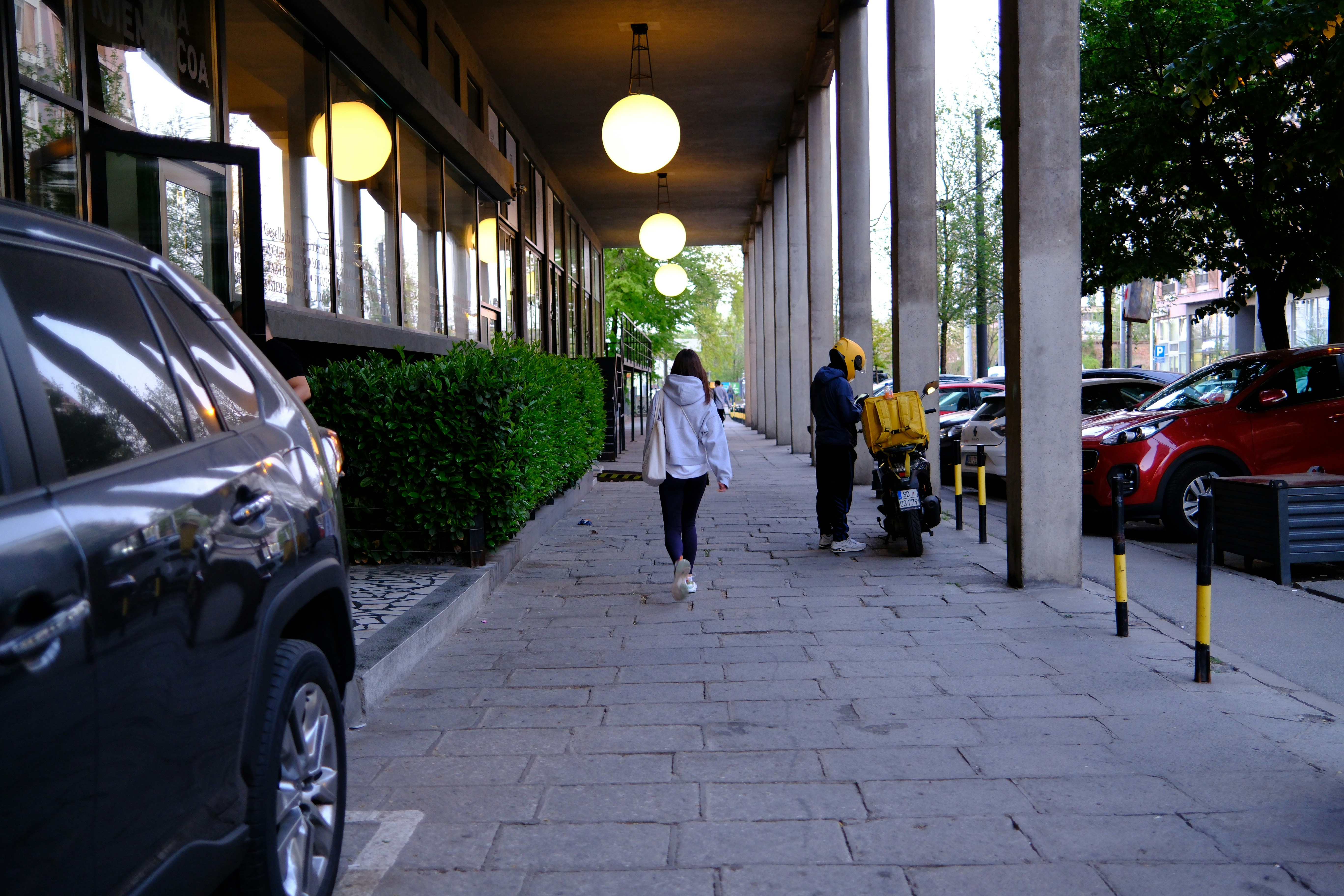 Line of Quiet Pedestrians under Glassy Orbs