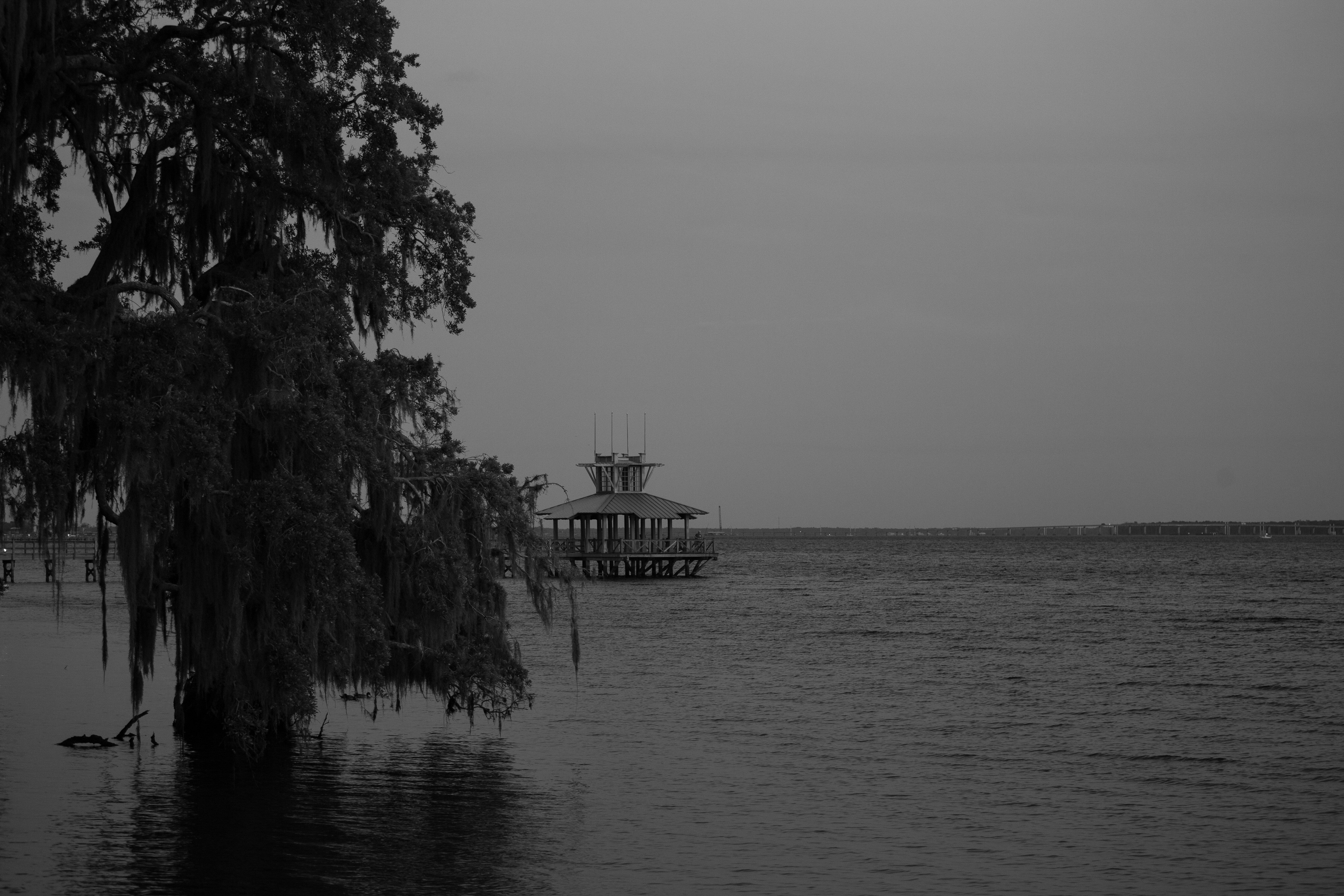 Still Waters and a Distant Pier: Quiet Horizon at Dusk