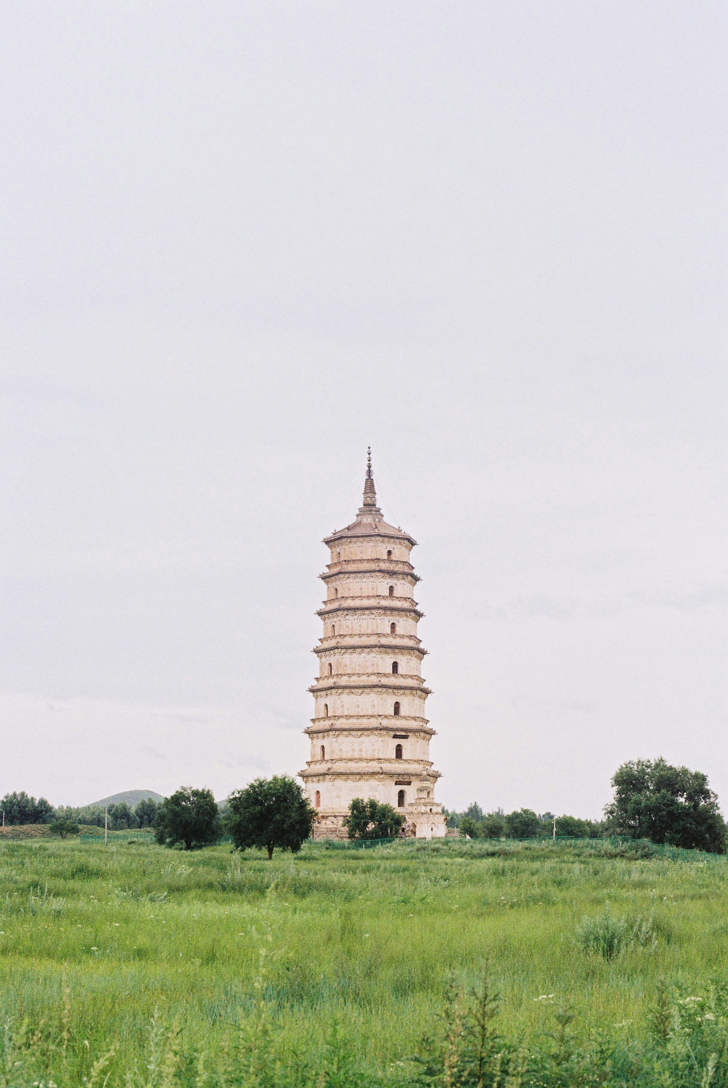 Silent Stages: A Lone Pagoda Rising Over a Quiet Field