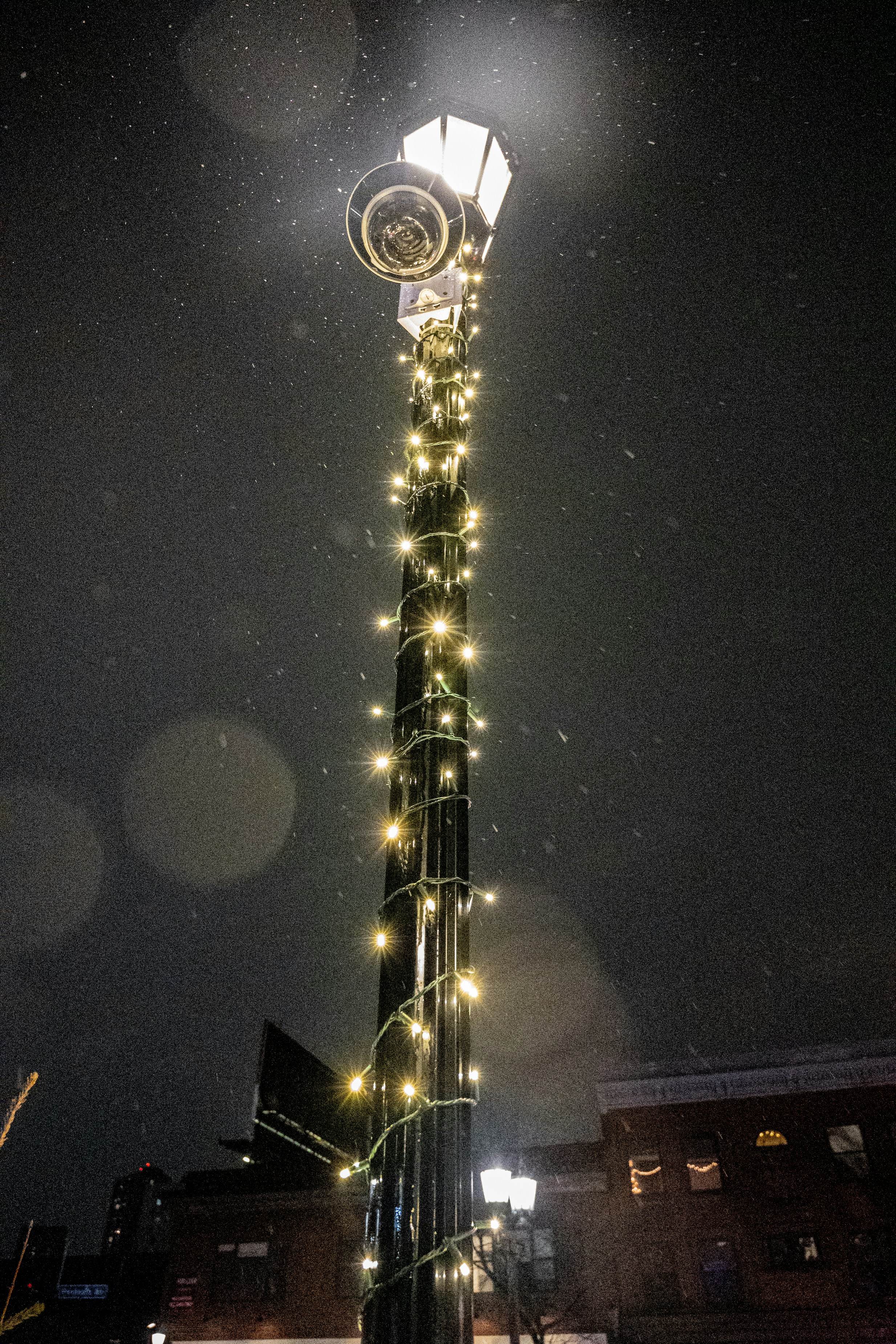 Snowy Night Lantern: A Festooned Streetlamp Reaching the Sky