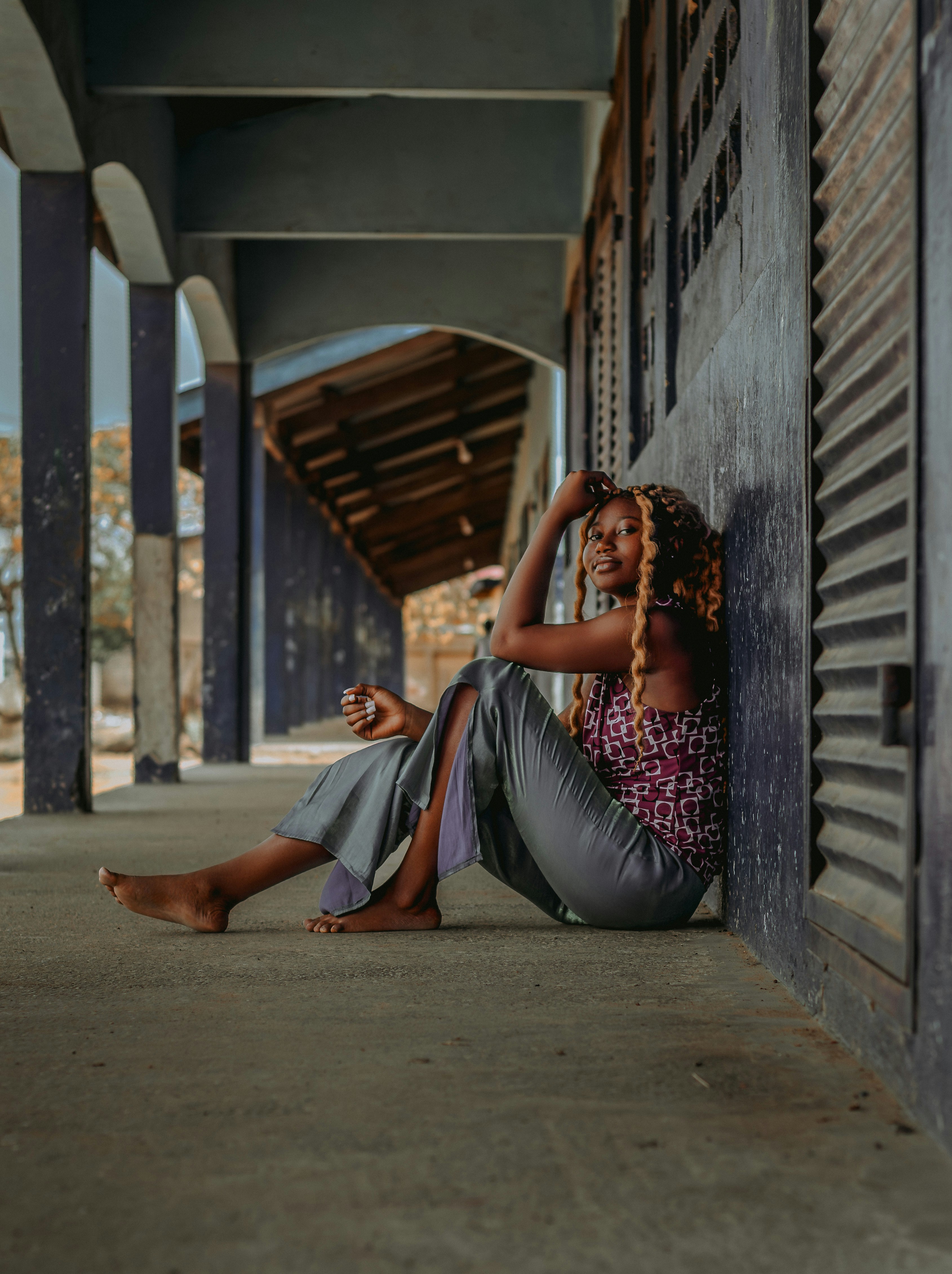 Sunlit Confidence: Portrait of a Quiet Moment Under the Archway