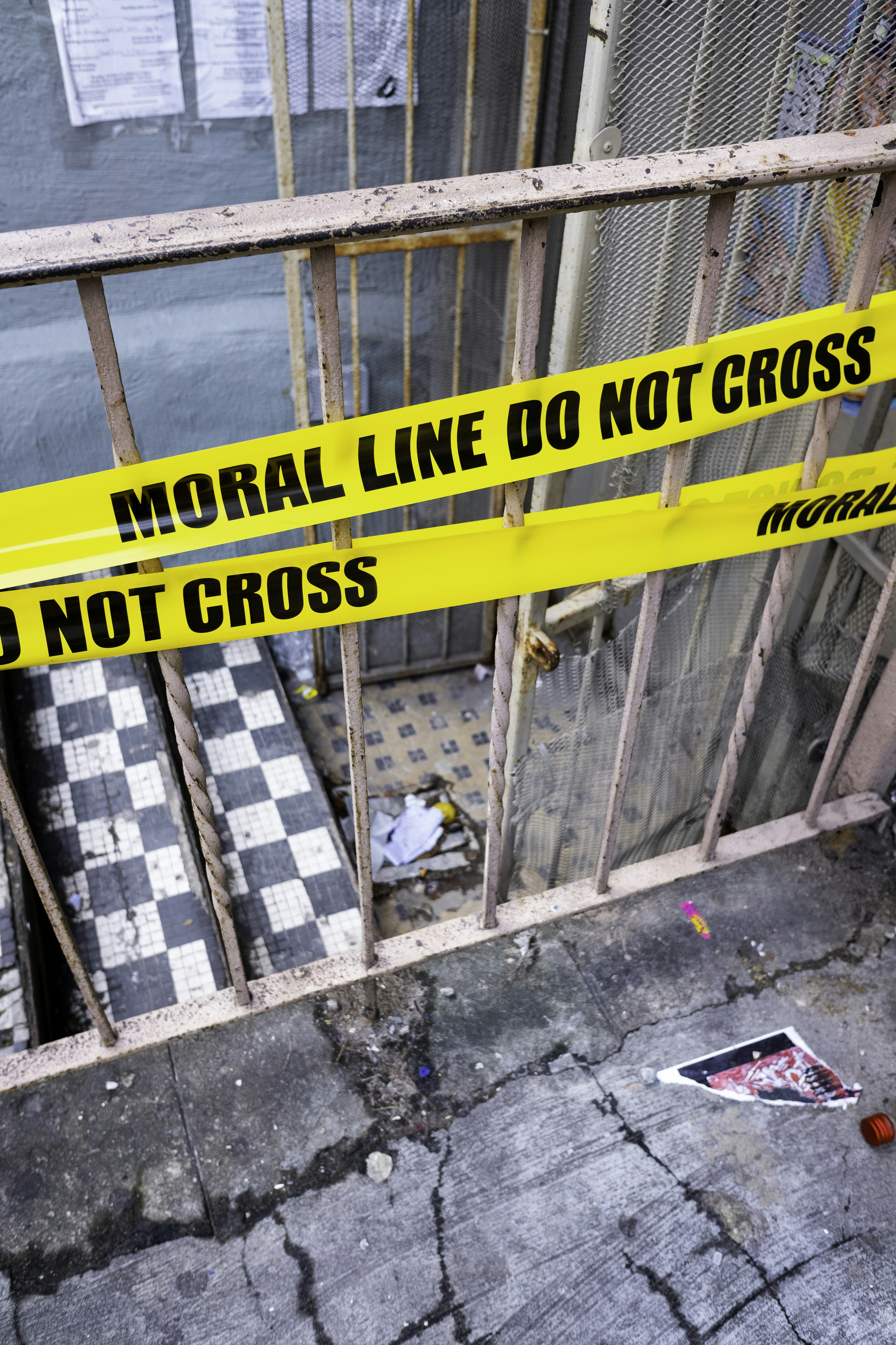 Yellow Tape Across a Deteriorating Balcony Barrier