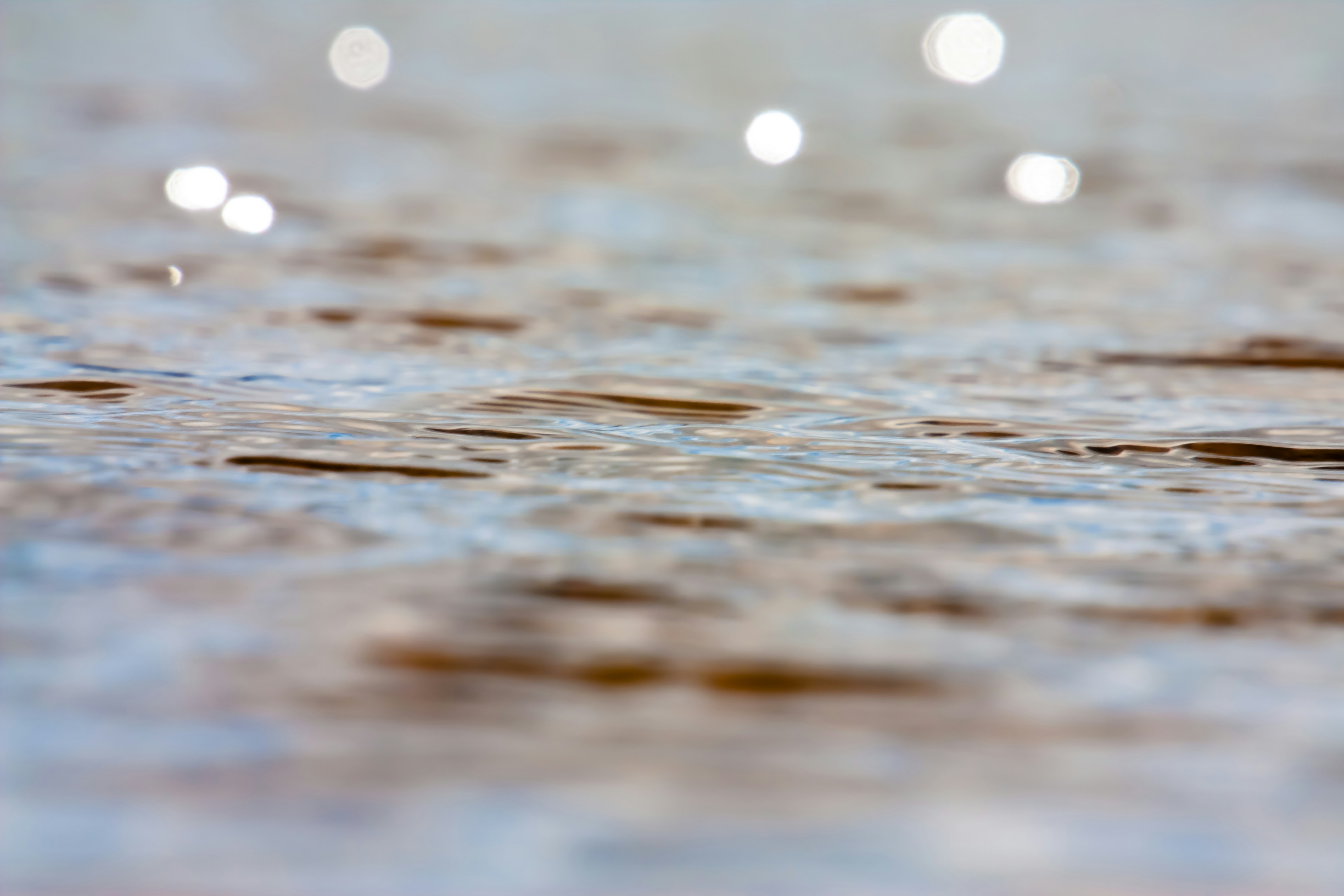 Bokeh Ripples: Glinting Orbs Above Quiet Lake