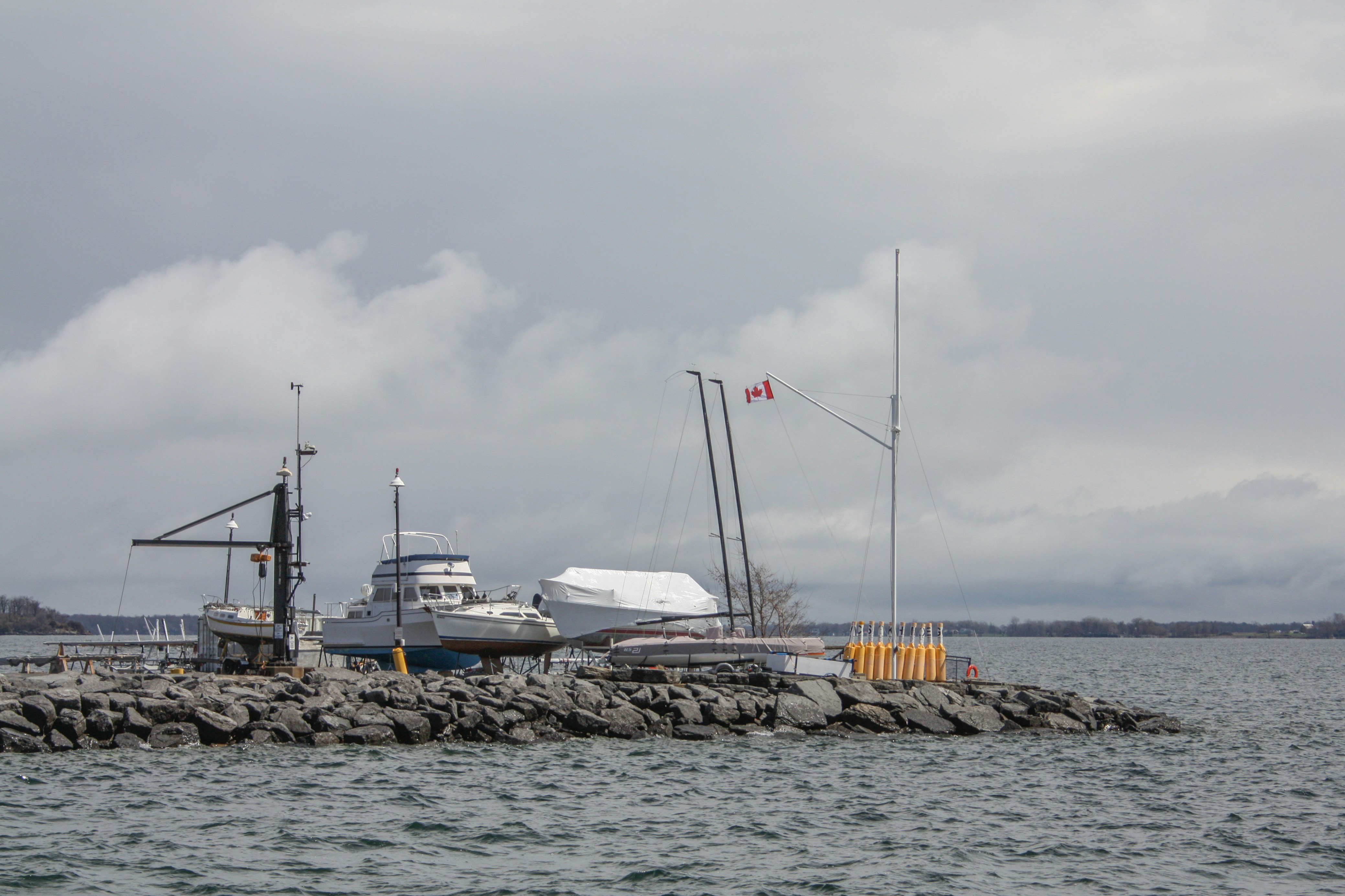 Quiet Jetty at Dusk: Boats Resting Against the Breakwater