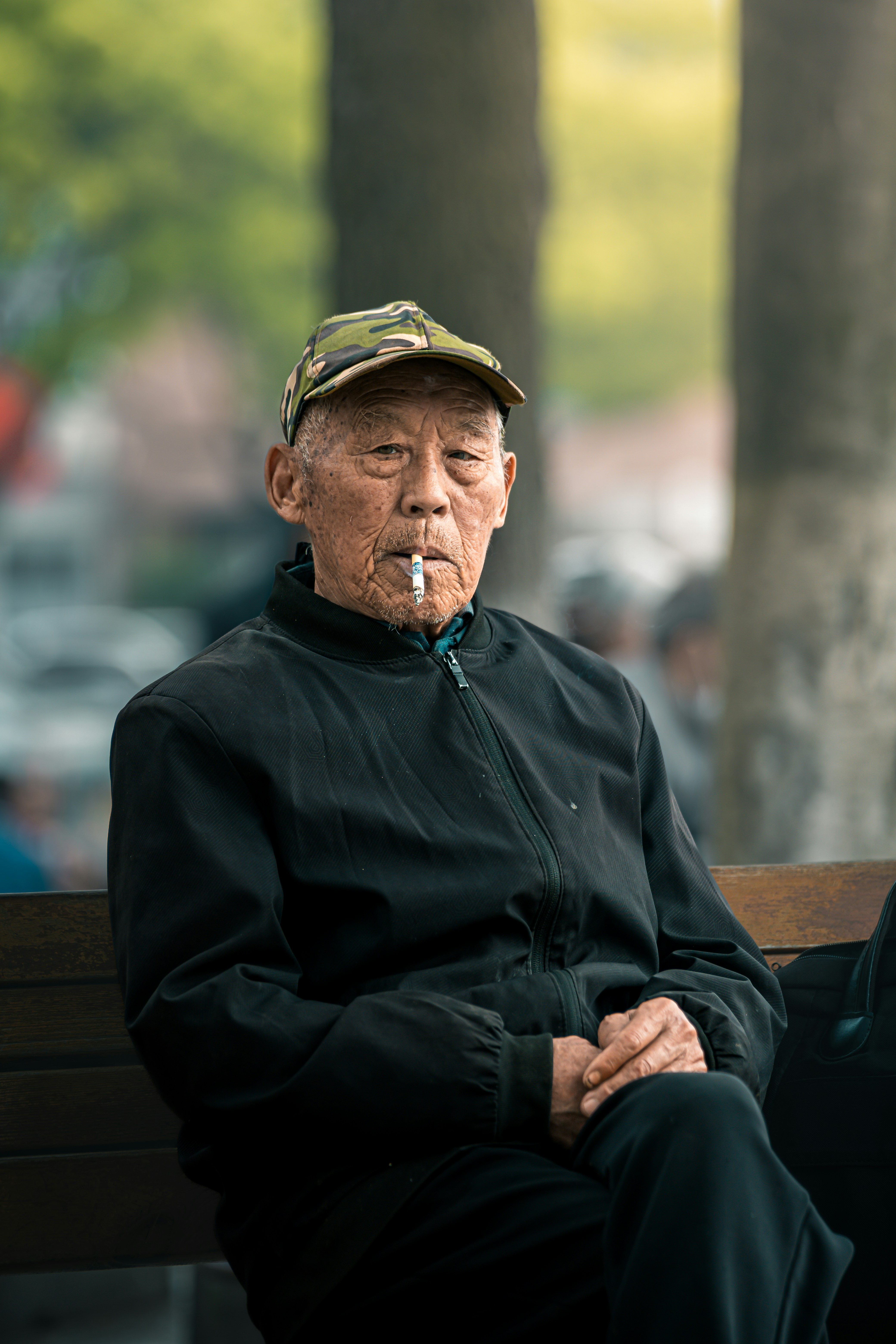 Quiet Moment on the Park Bench: Elder with Cigarette