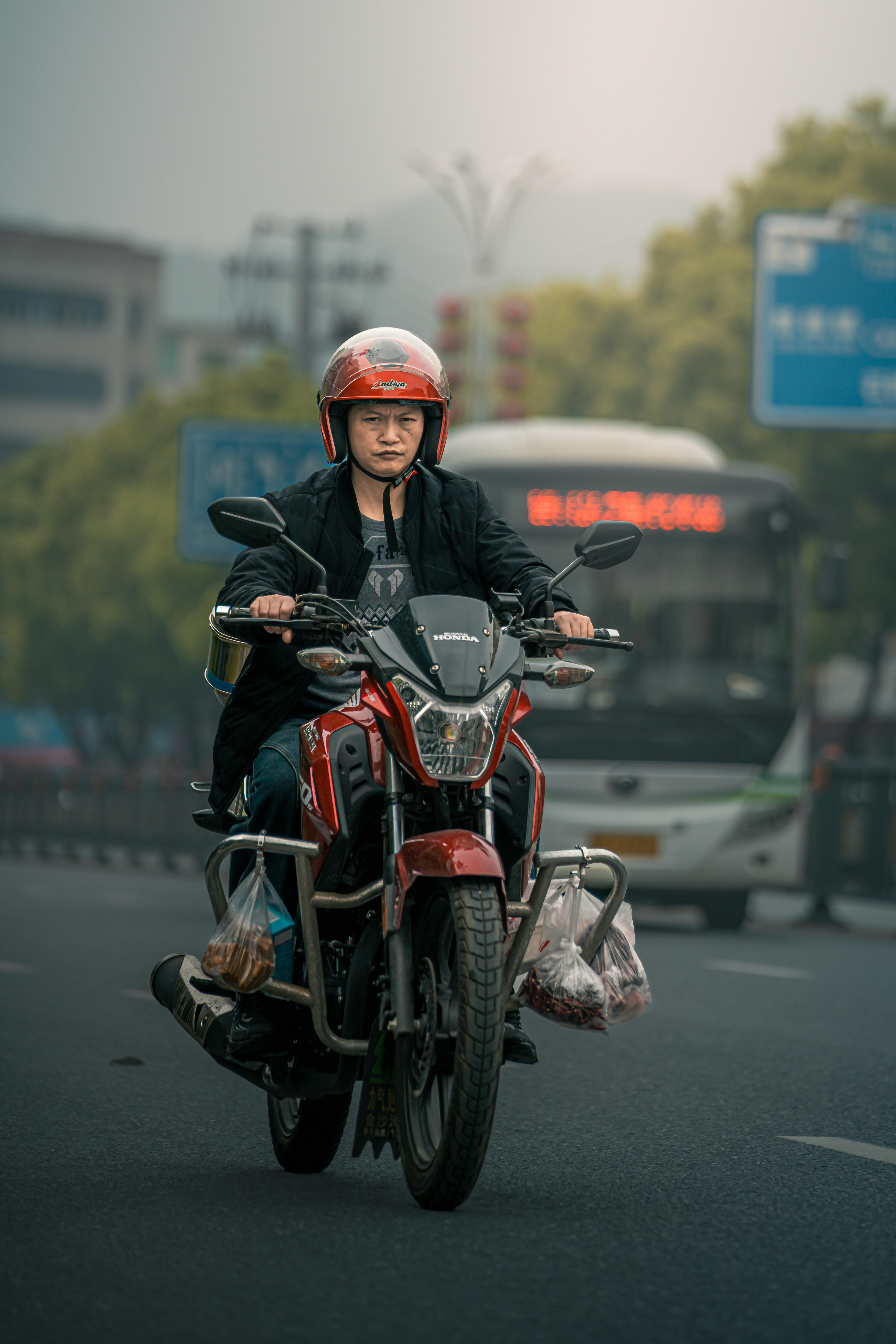 Portrait of a Rider in the City: Red Helmet, Front-Focused on the Motorcycle