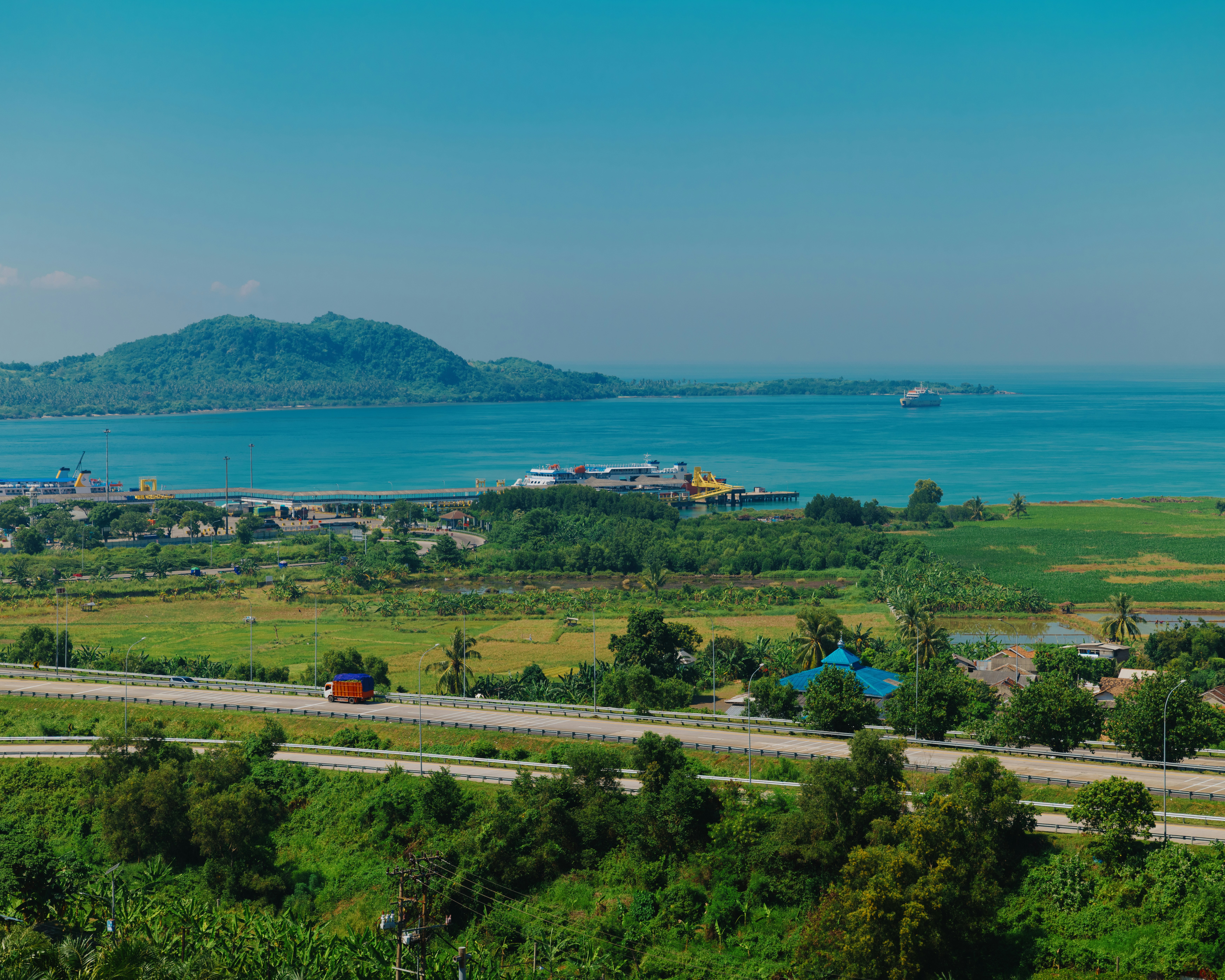 Coastal Horizon: Emerald Fields Meet the Sea