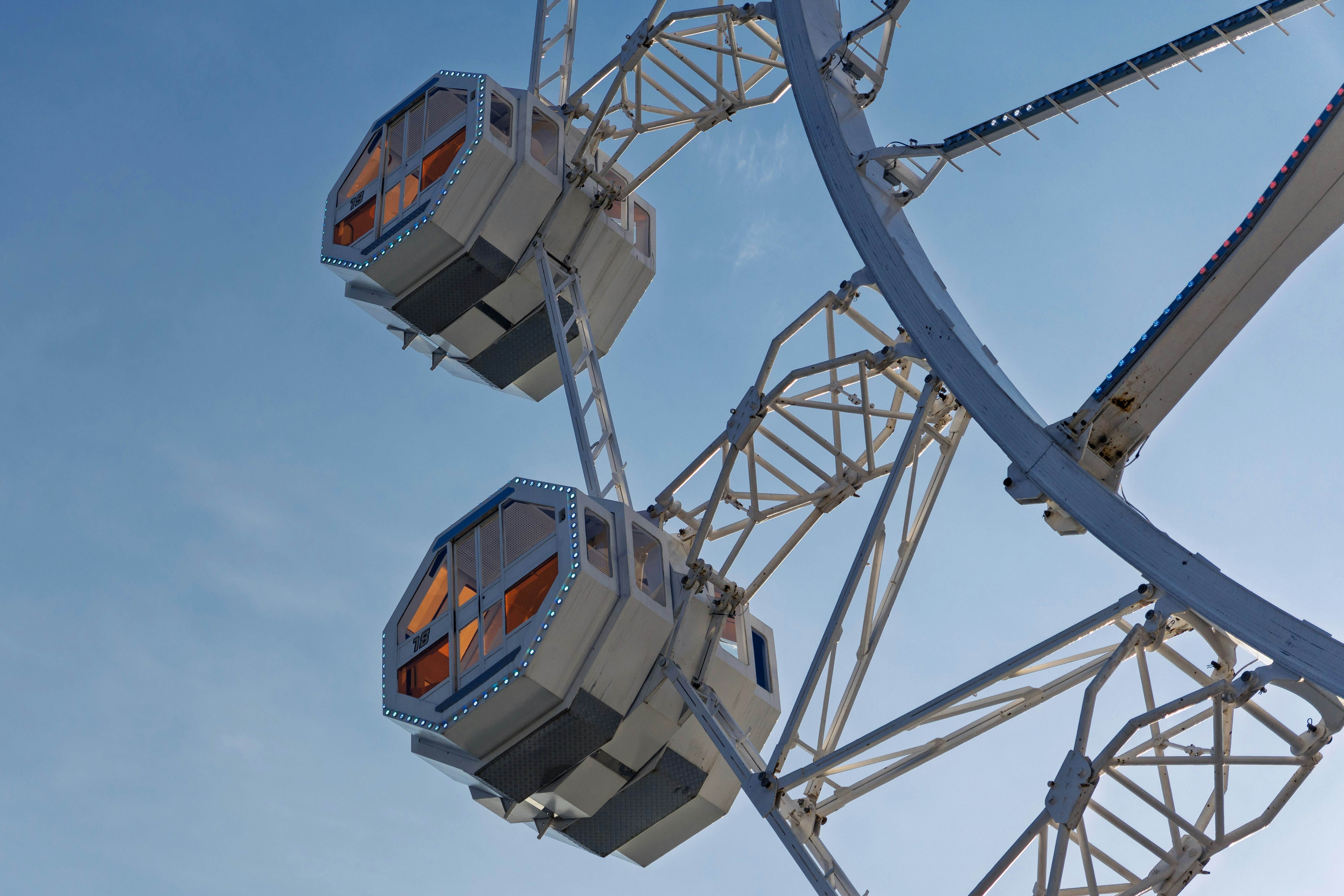 Glistening Ferris Wheel Segments Against a Clear Sky