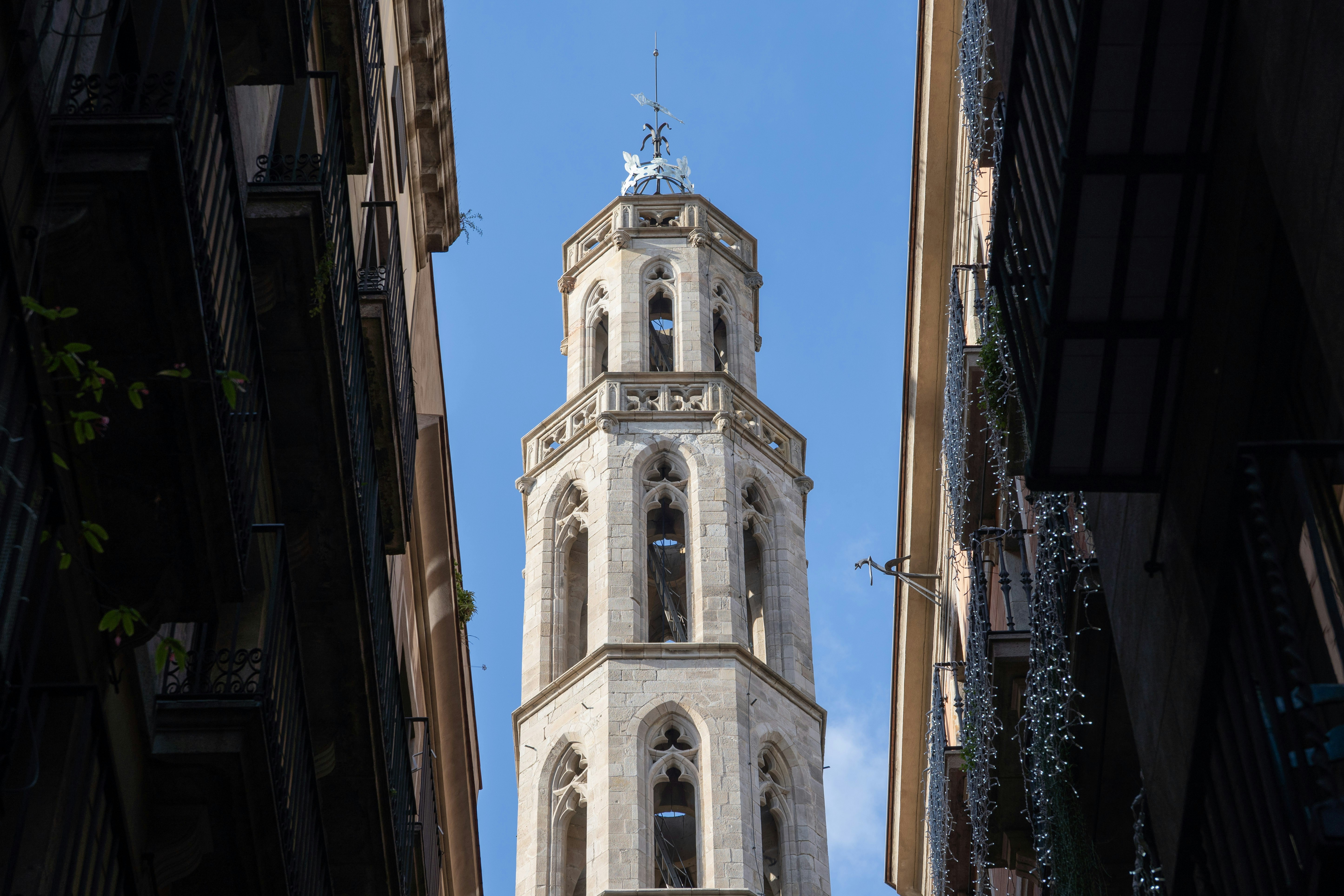 Towering Carved Stone Amid Narrow, Sunlit Alley