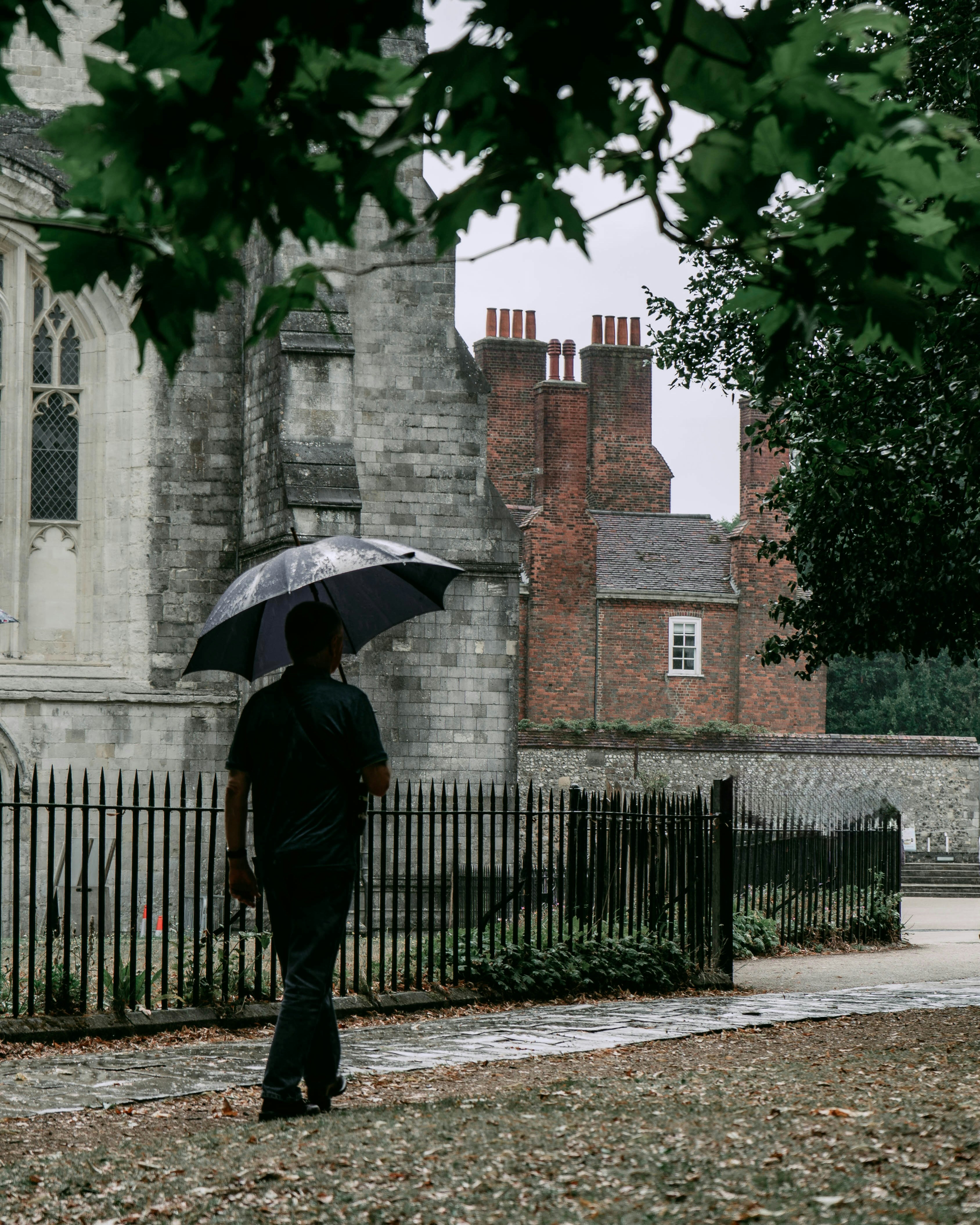 Umbrellaed Figure at the Quiet Cloister Verge