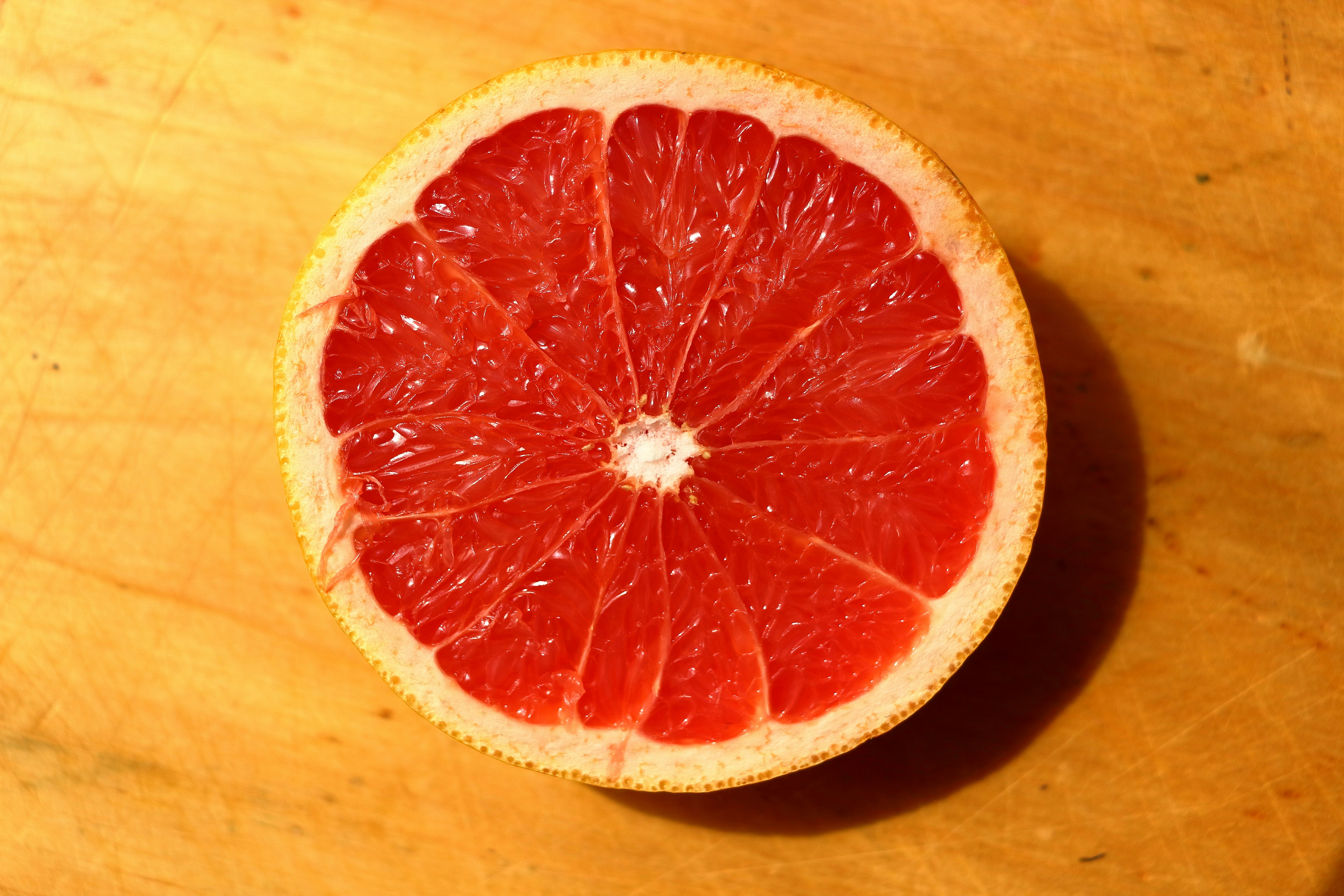 Citrus Core: A Halved Grapefruit on a Wooden Surface