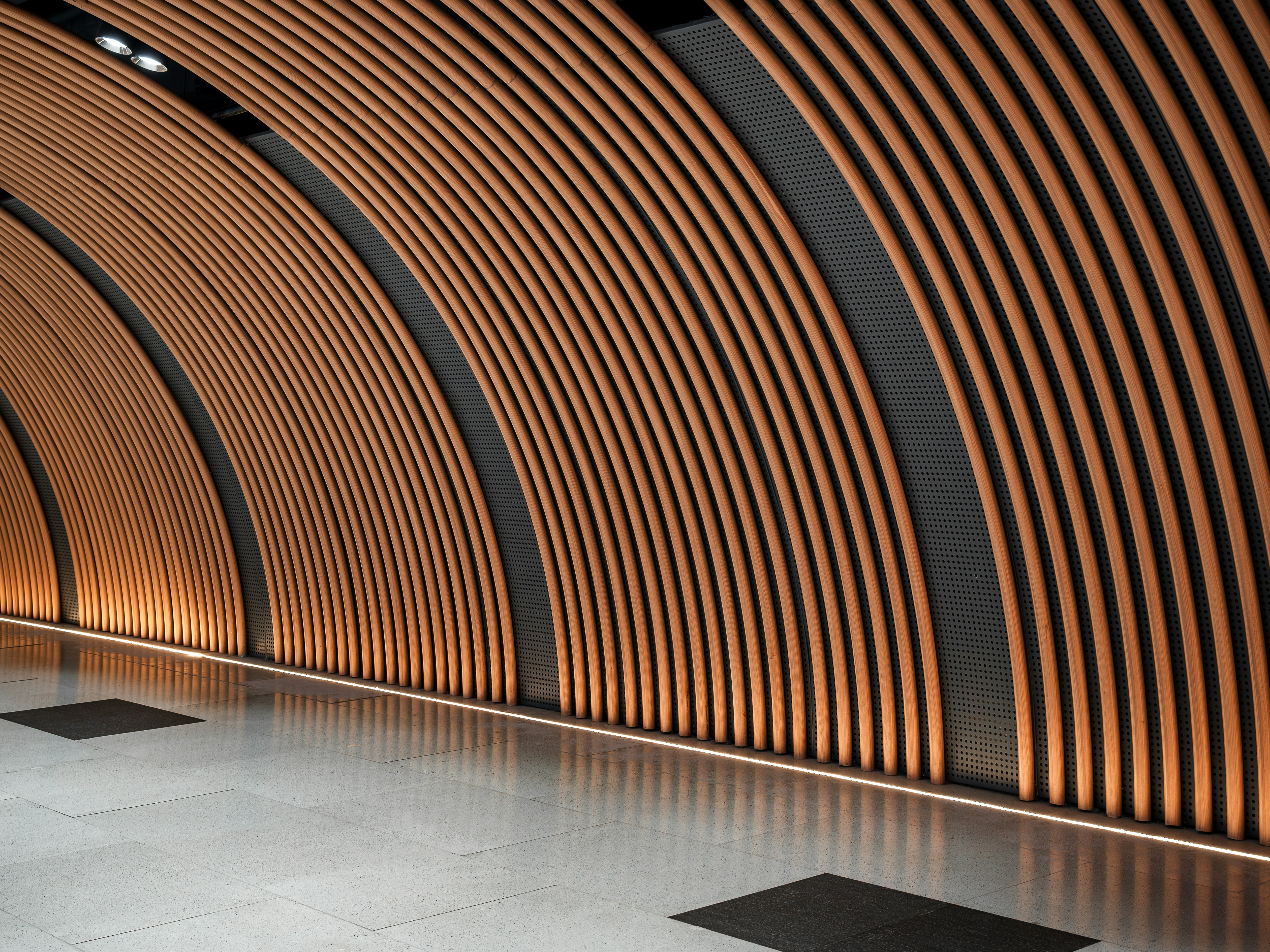 Arcade of Light: Orange Ribs in a Modern Passage