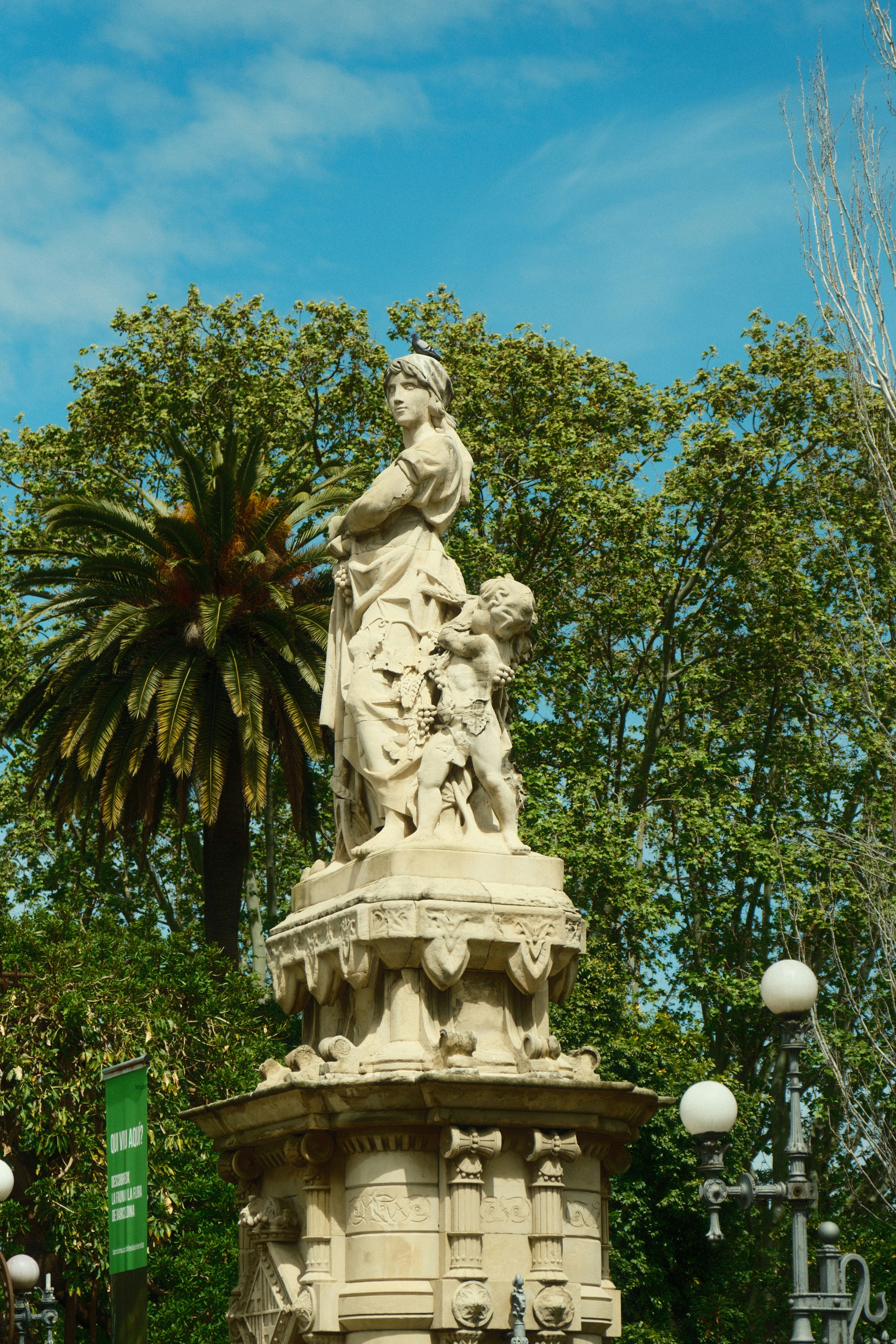 Stone Statue Serenade: A Classical Display amid Sunlit Foliage