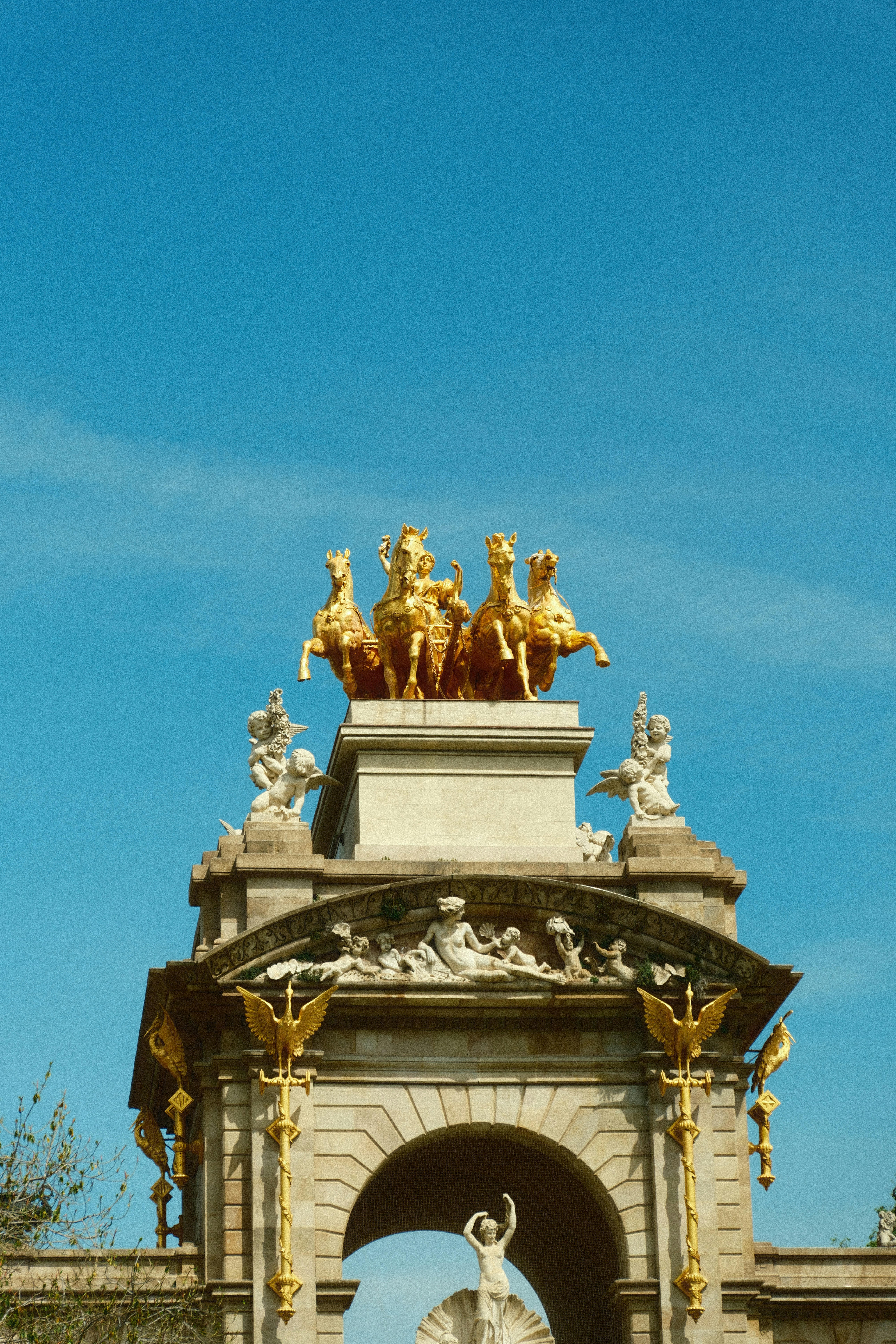Golden Cavalcade: Statues Crowned Above the Arch