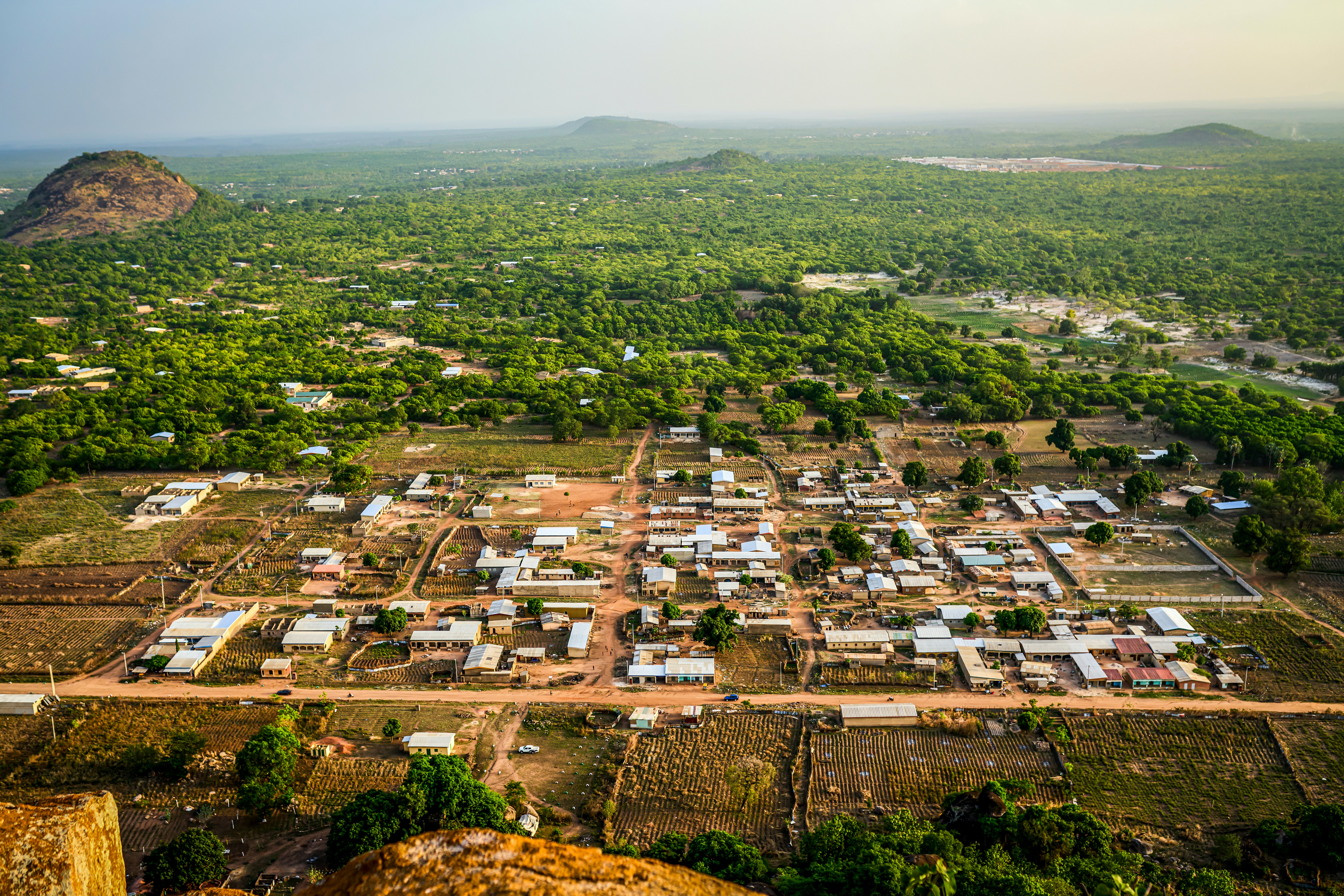 Sunlit Clay Streets: A Distant Aerial Over a Rural Town