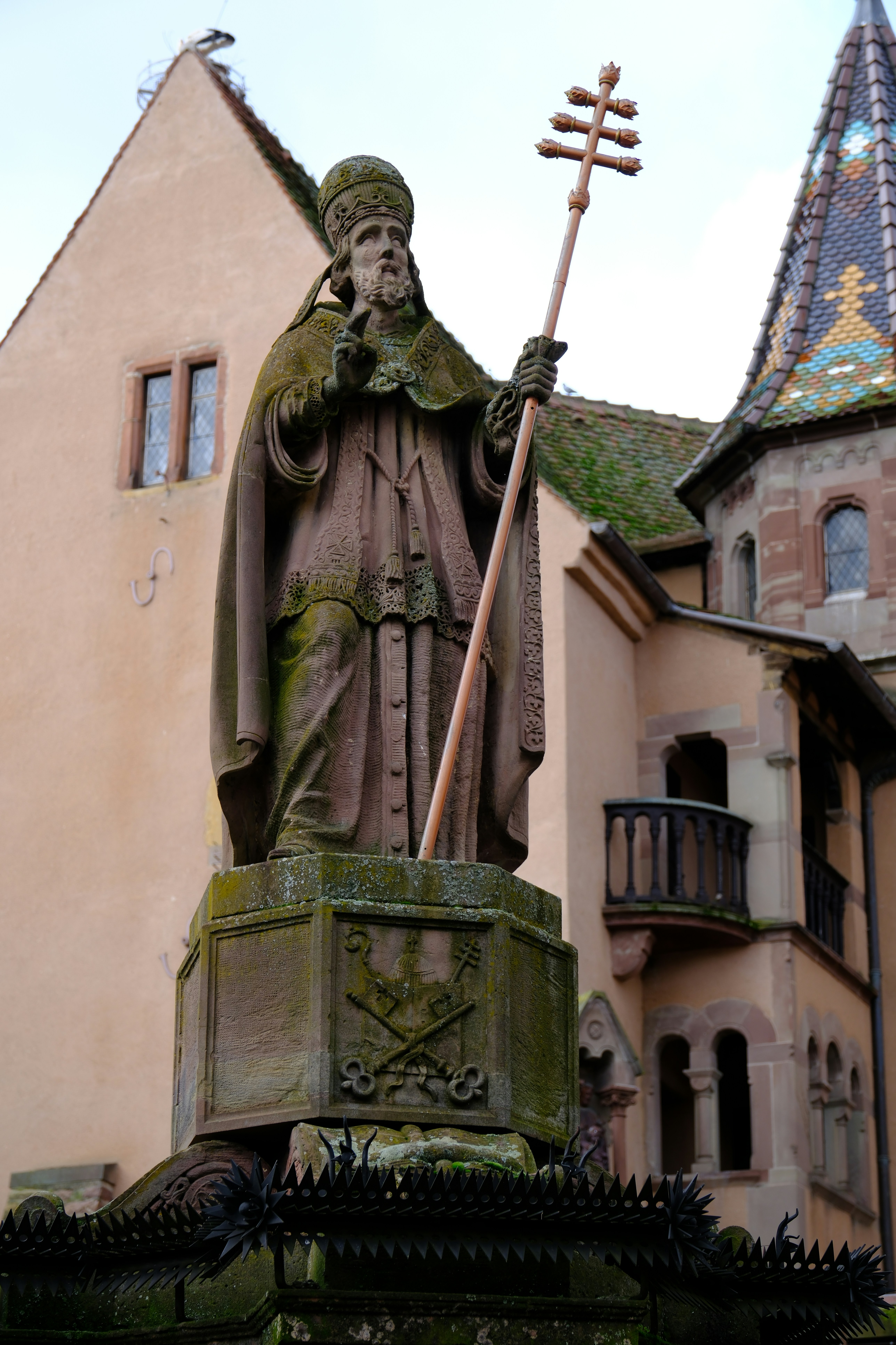 Guardian in Stone: A Saintway Statue Watching Over the Courtyard