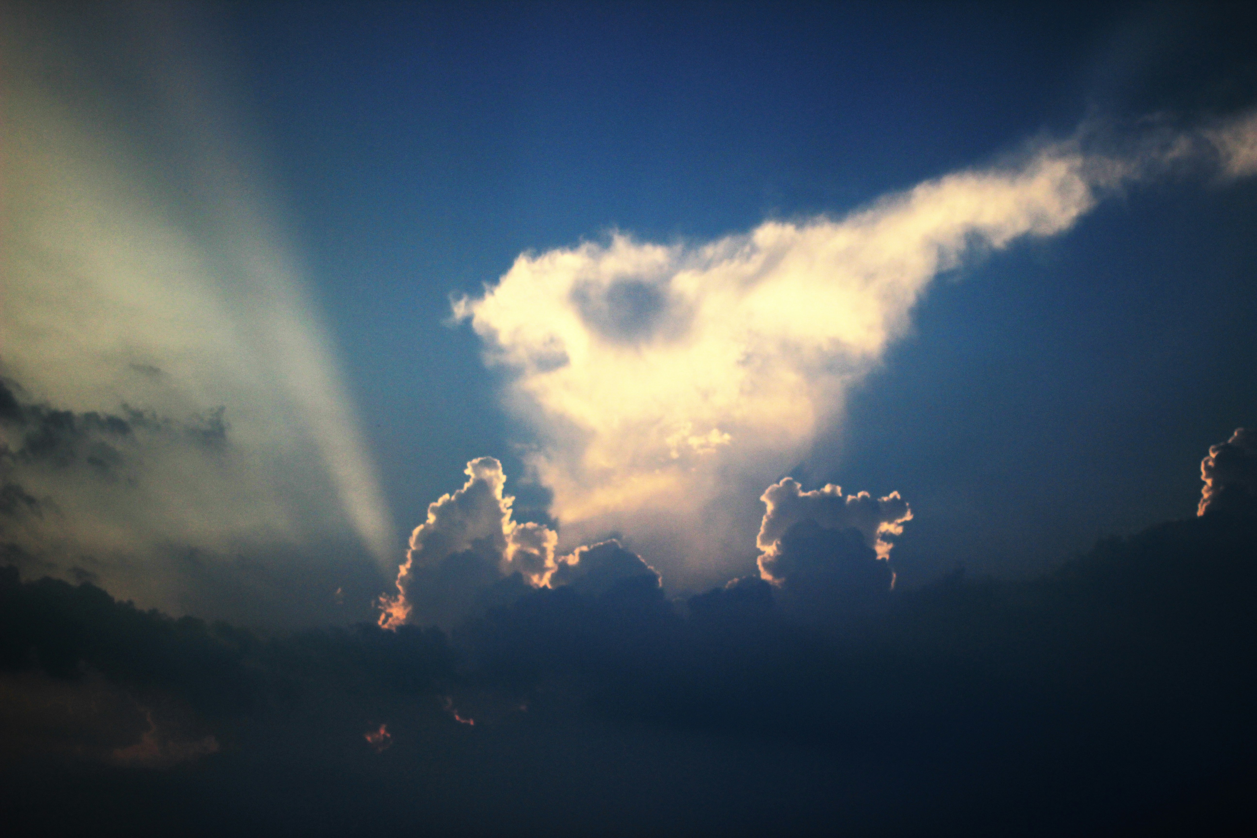 Sunlit Cloud Crest Piercing the Dark
