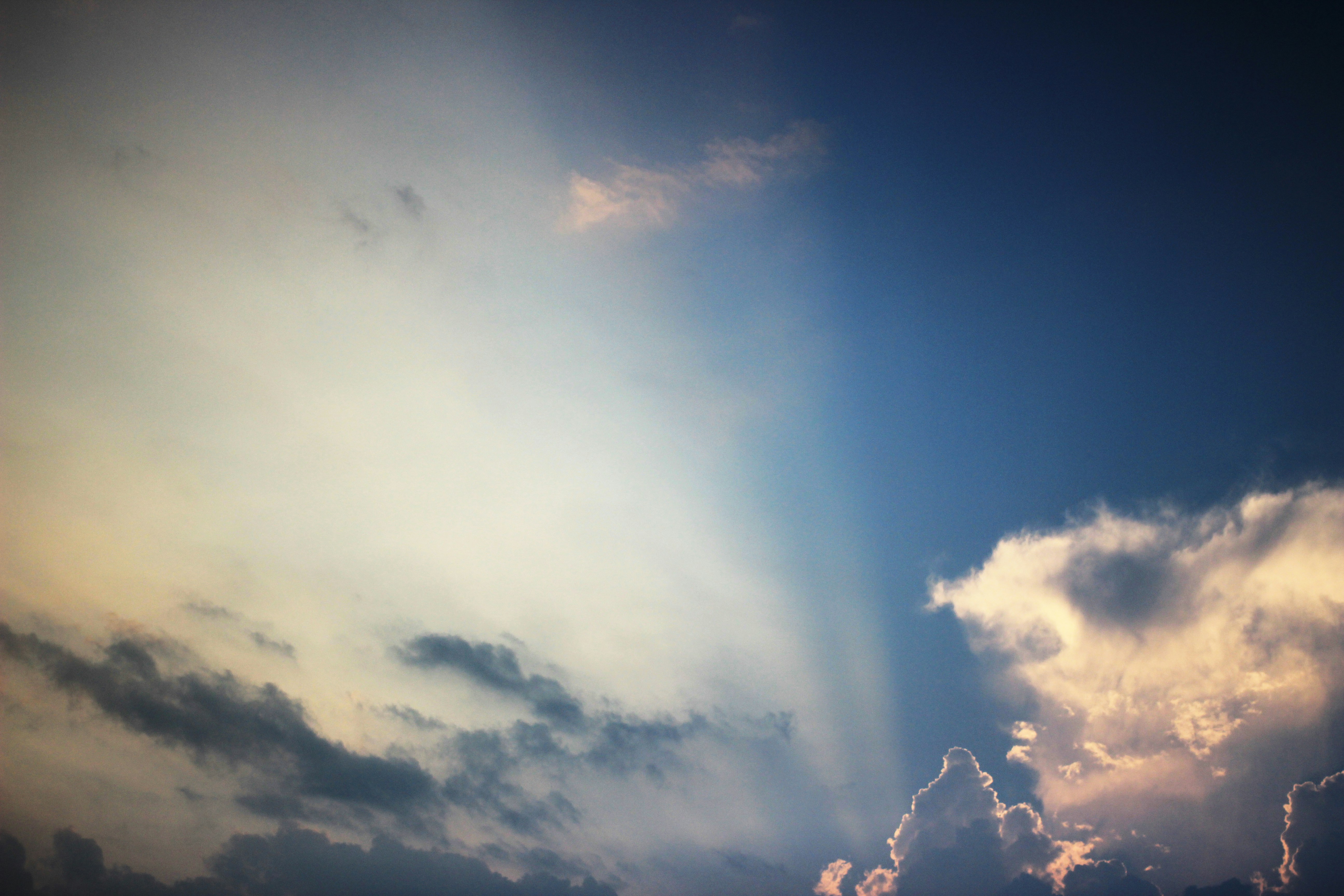 Luminous Sky Ribbon: Dawn Light Weaving Through Clouds