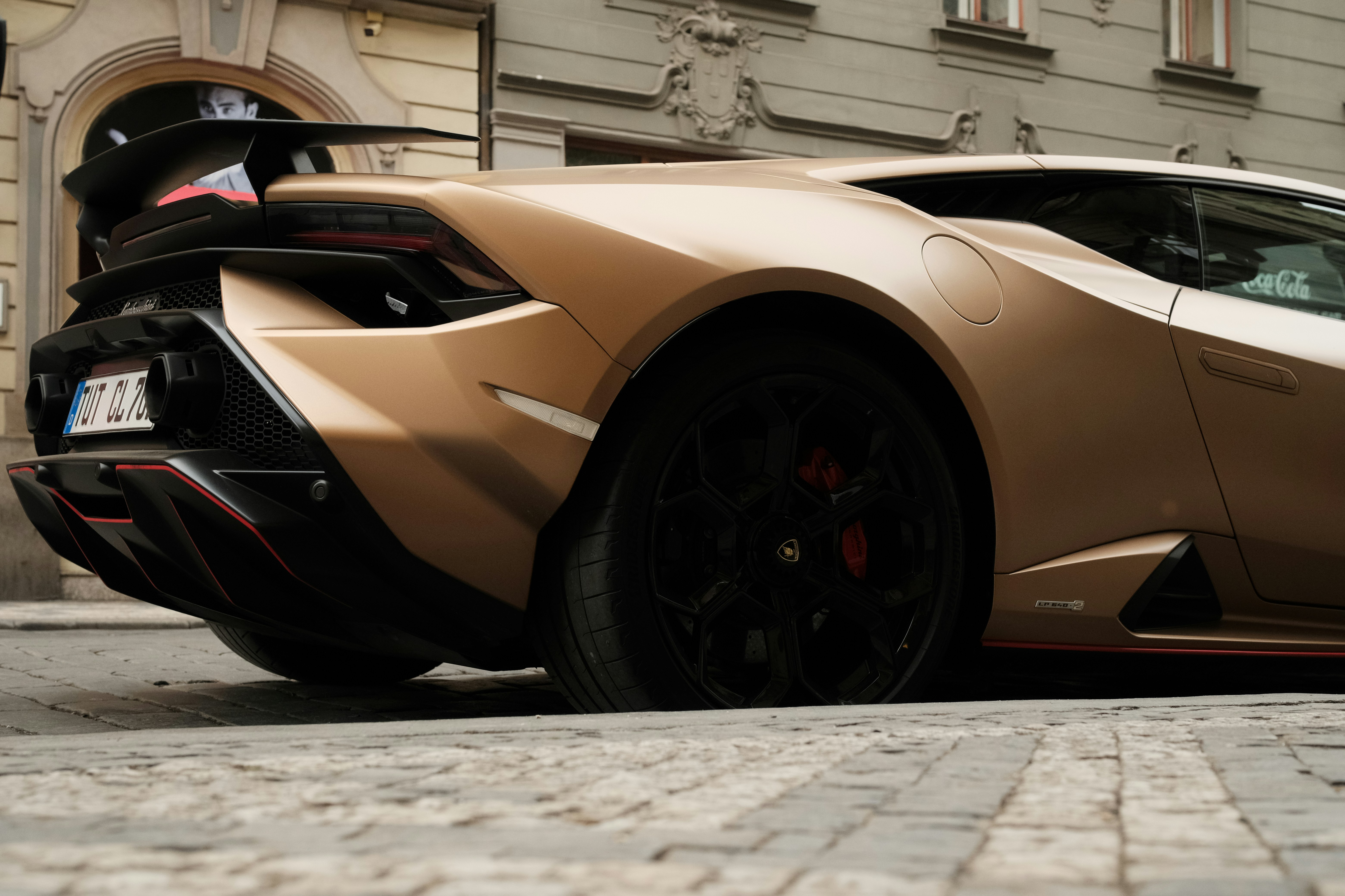 Gilded Veloce: A Car's Bold Stance on Cobbled Streets