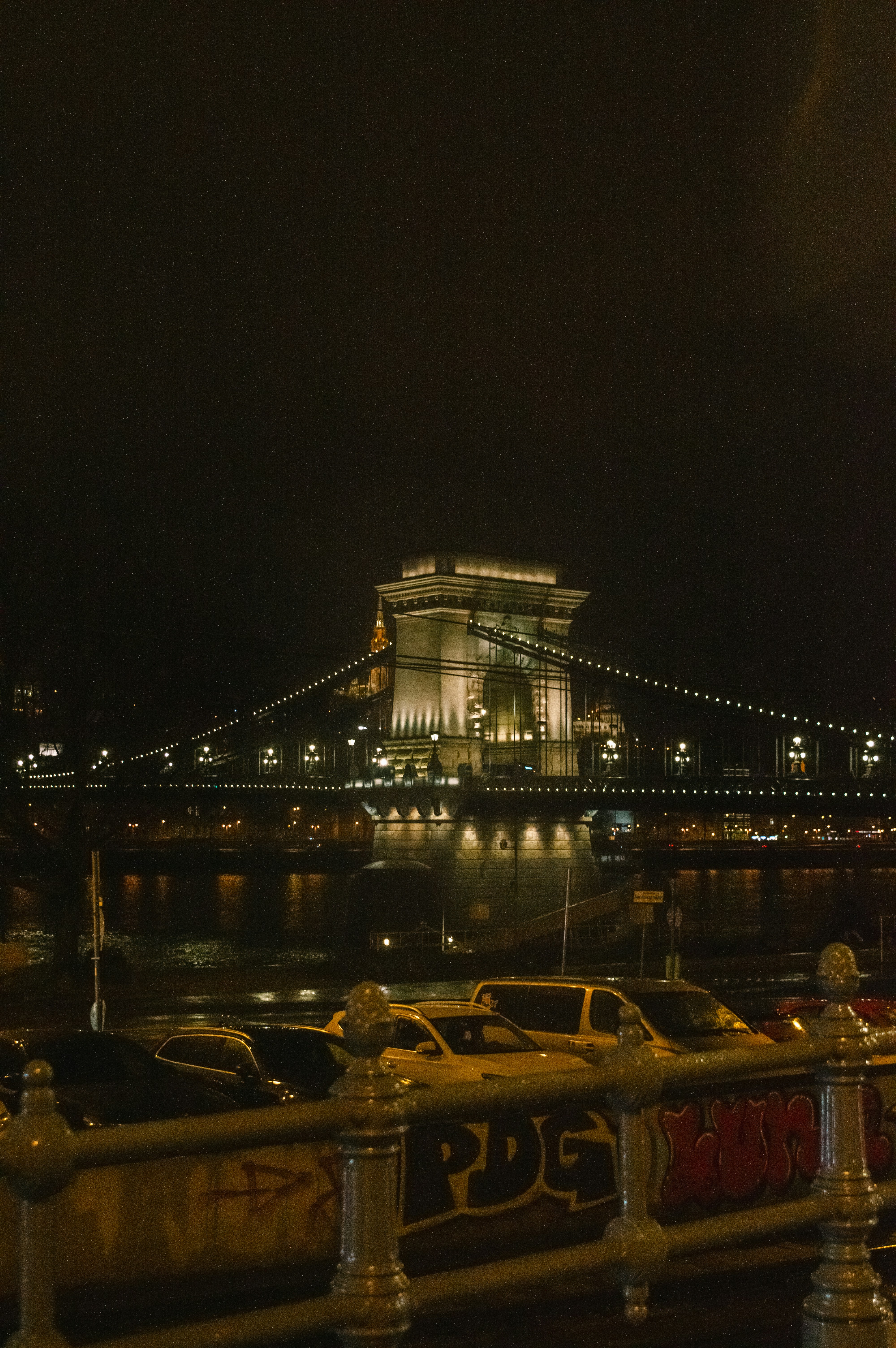 Nighttime Bridge Serenity: Chain of Lights Over the Danube