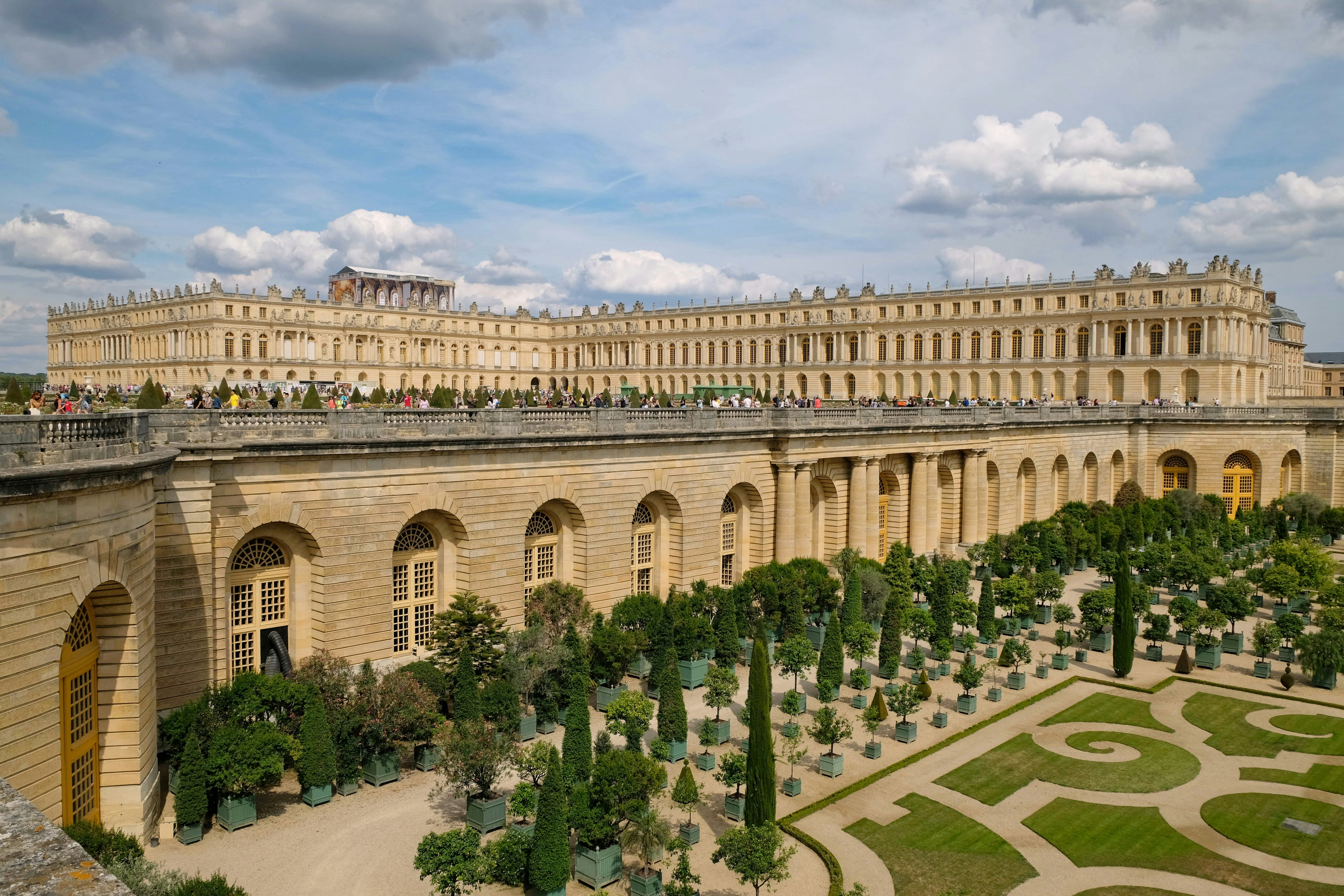 Ornate Terrace and Parterre of Versailles-like Estate Under a Blue Sky