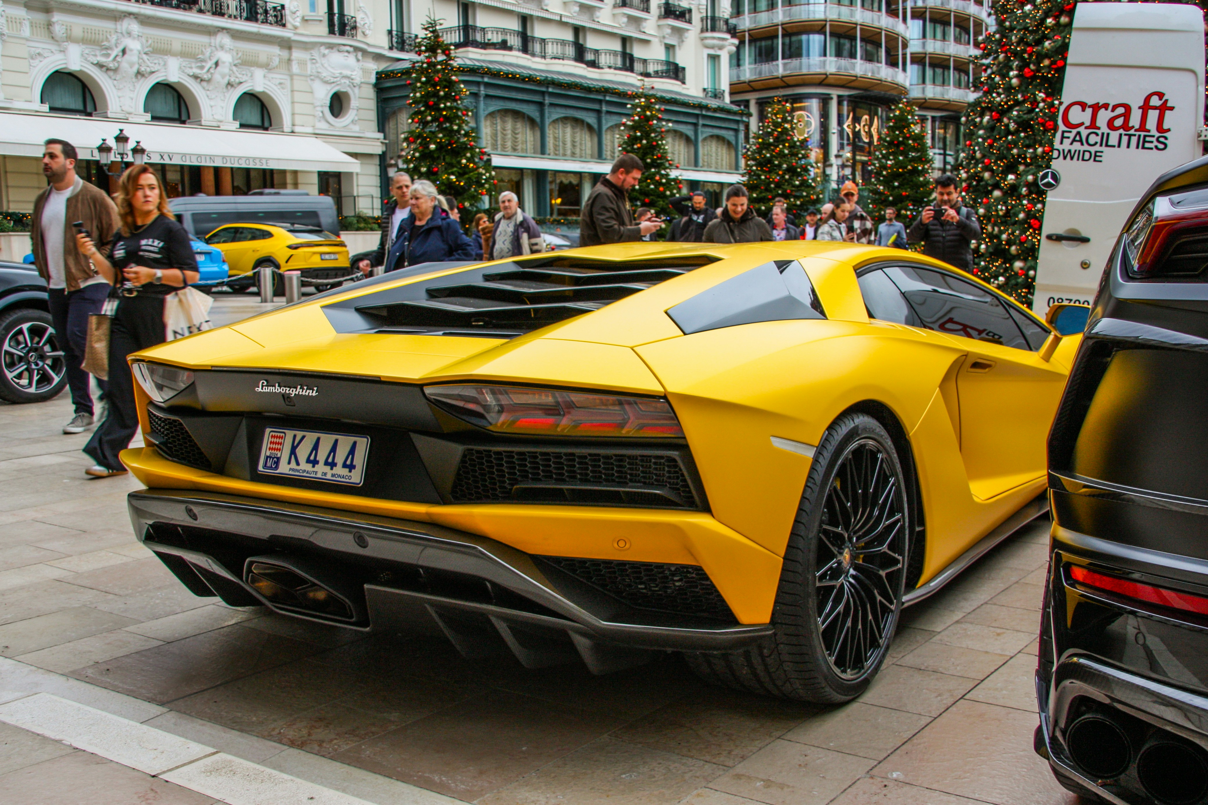 Lamborghini Huracán on a bustling city plaza, captured among holiday decor