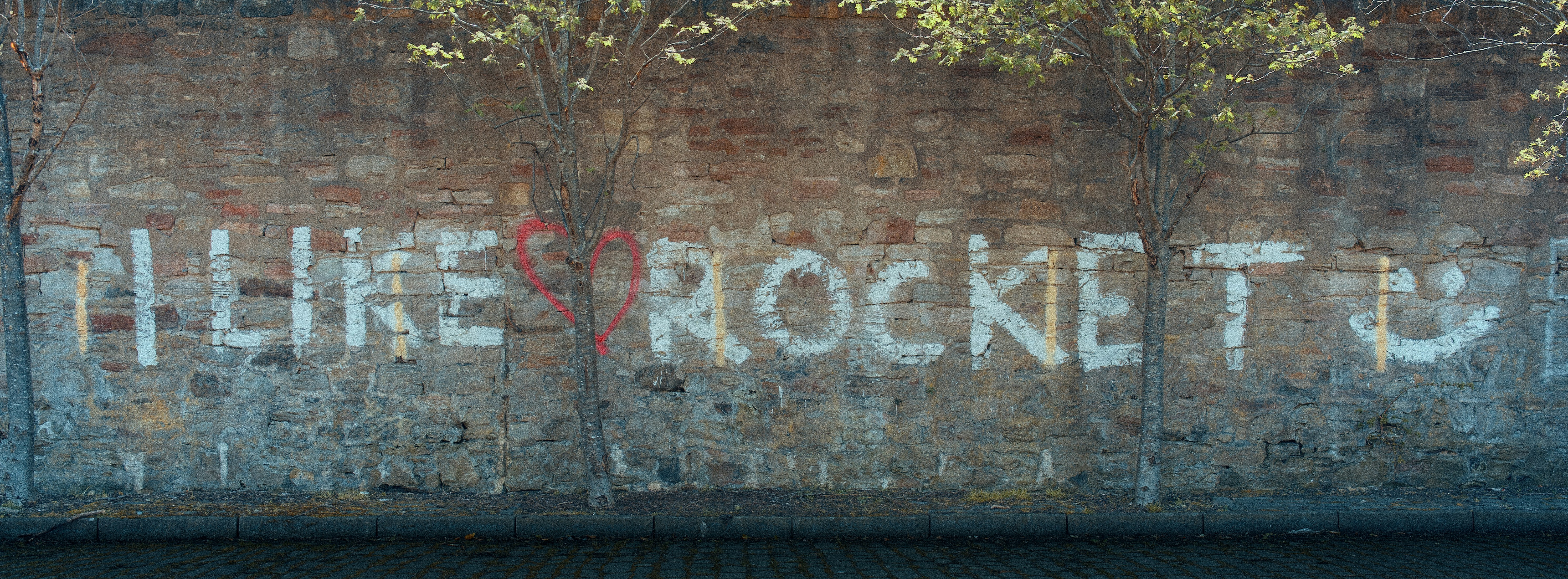 Cracked Canton of Chalk: A Graffiti Heart on a Weathered Brick Wall