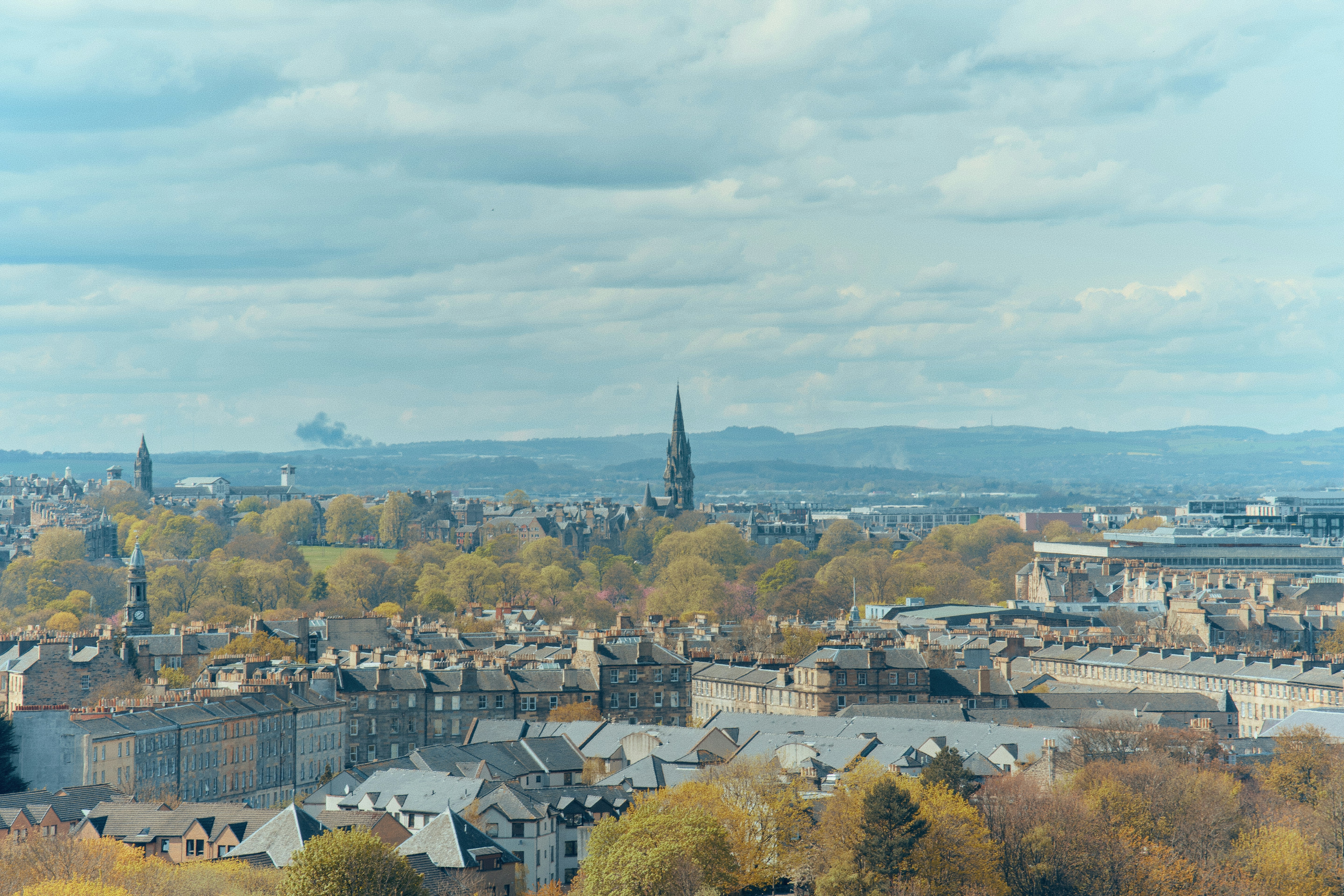 Distant Cathedral Spire Rising Above Autumn City Roofscape