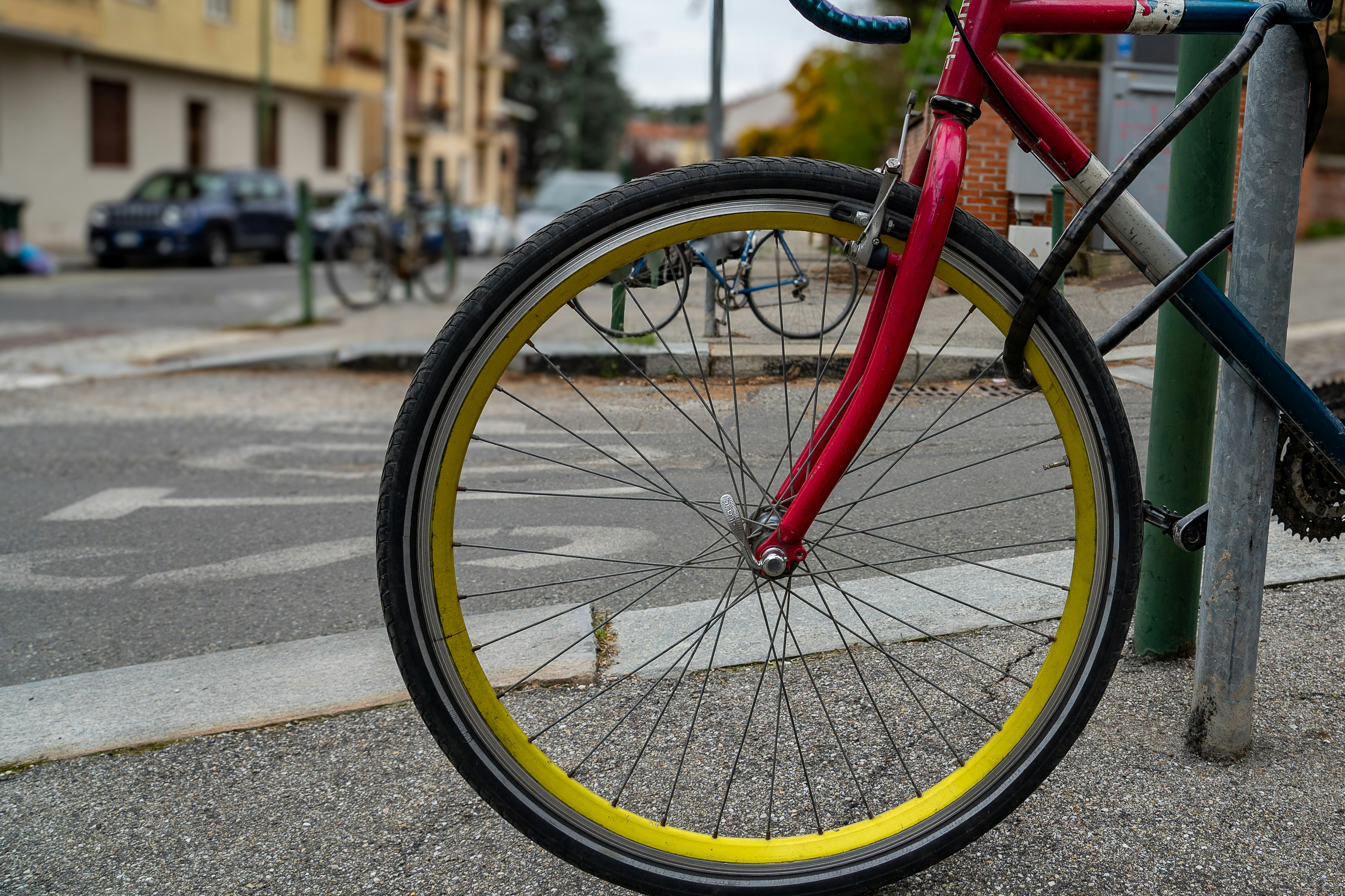 Yellow-rimmed Front Wheel as the City Meets the Bike