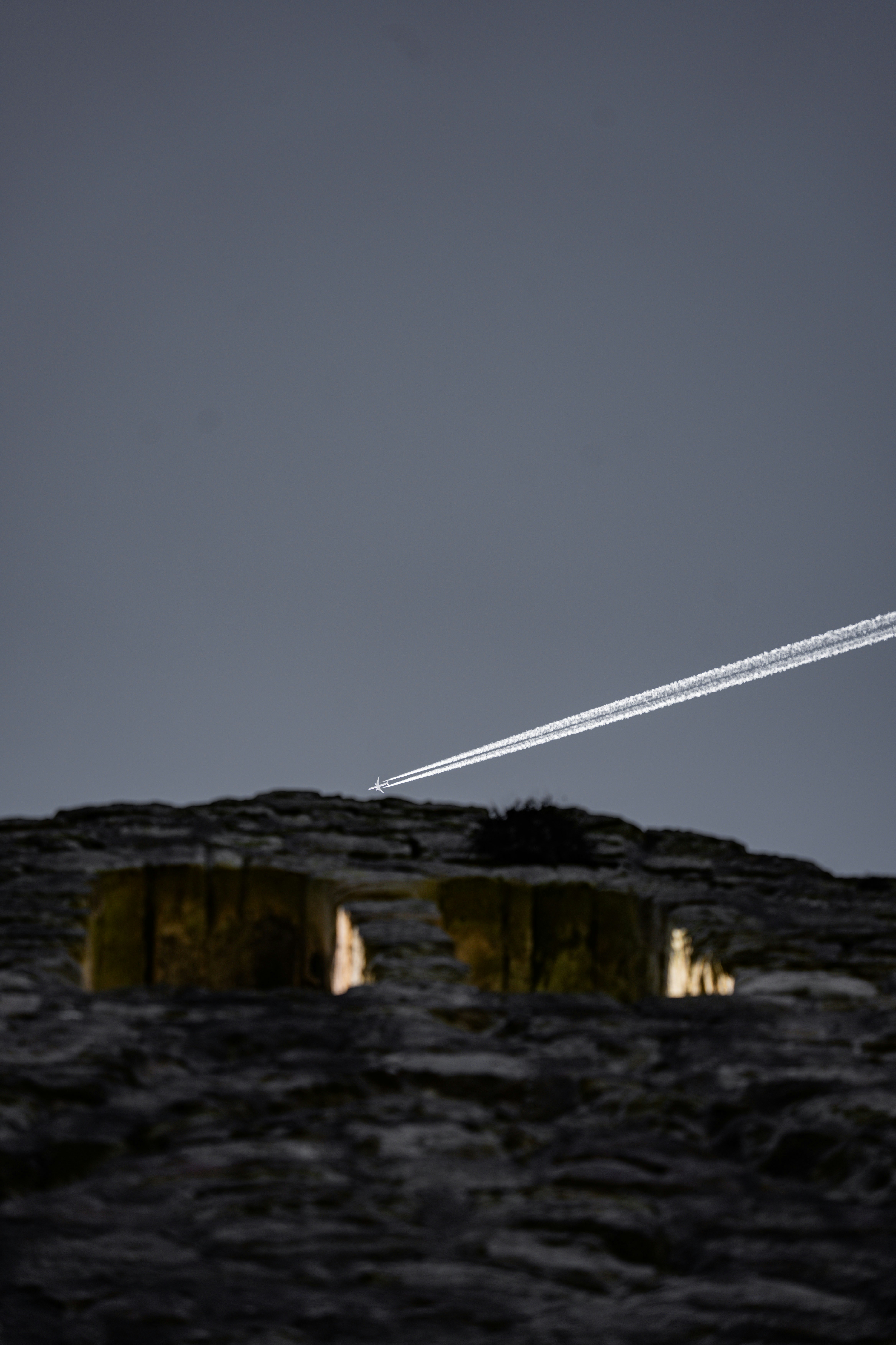 Moonlit Ruins Under a Skytrain Jet