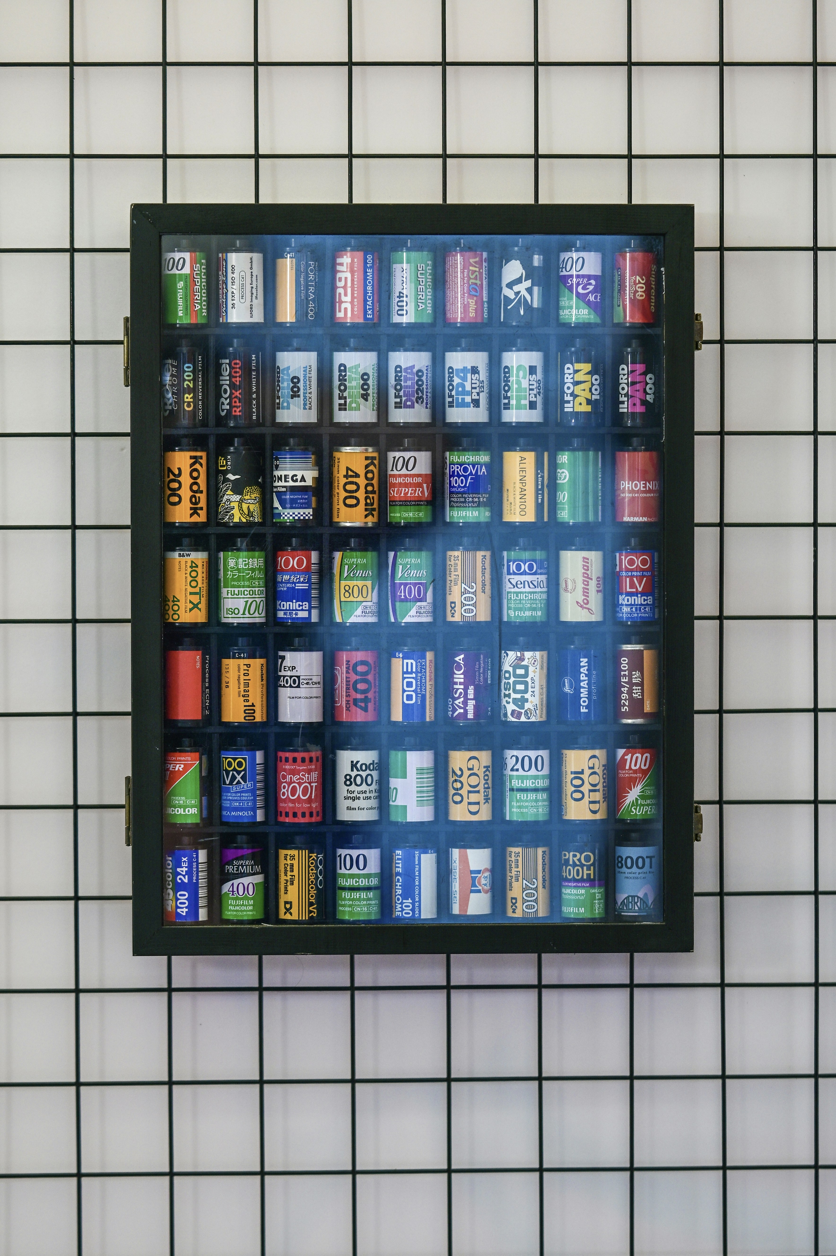 Colorful Pharmacy Grid: A Framed Mosaic on Tiled Wall