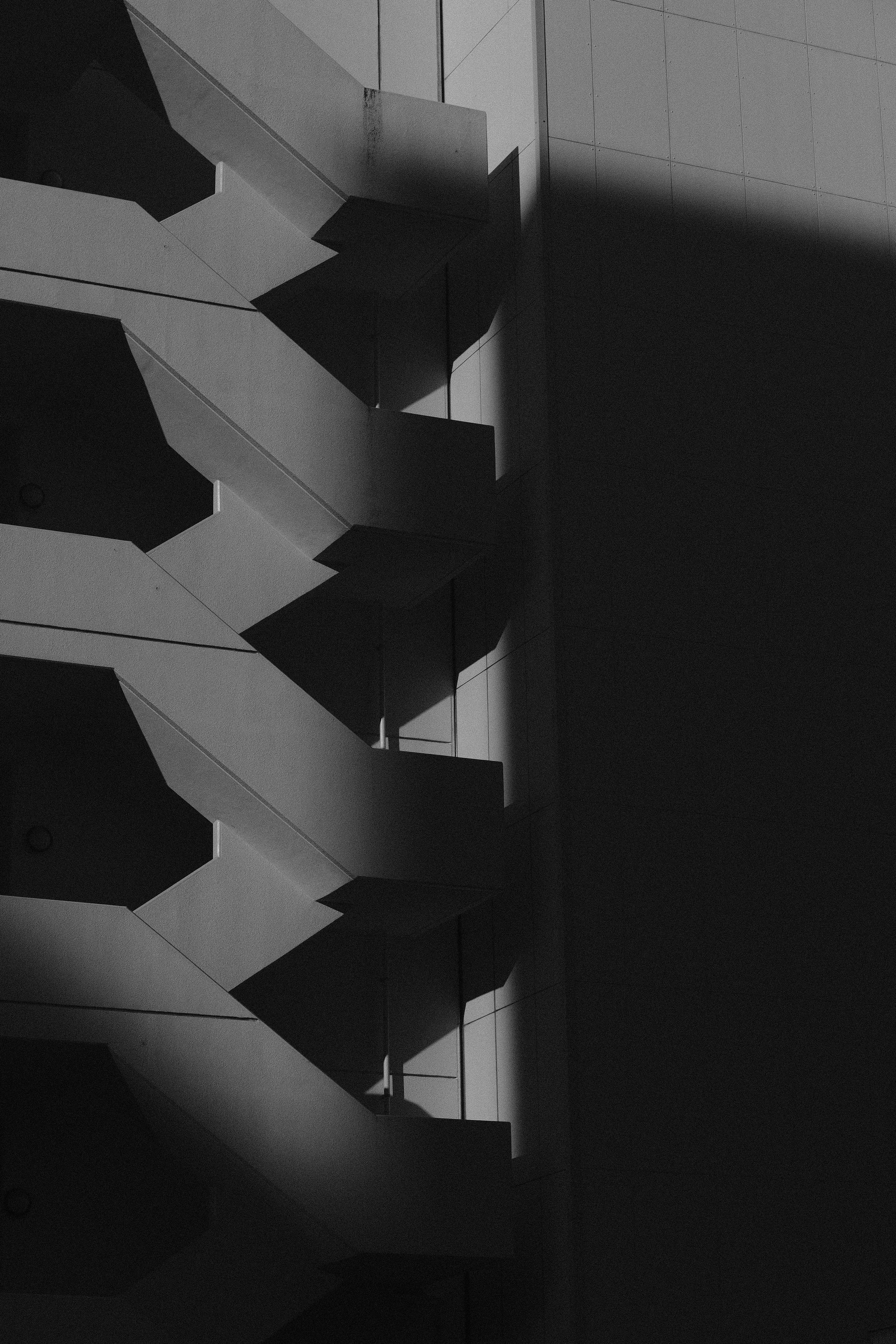 Shadowed Facade: Repeating Concrete Minutiae Along a Sunlit Edge