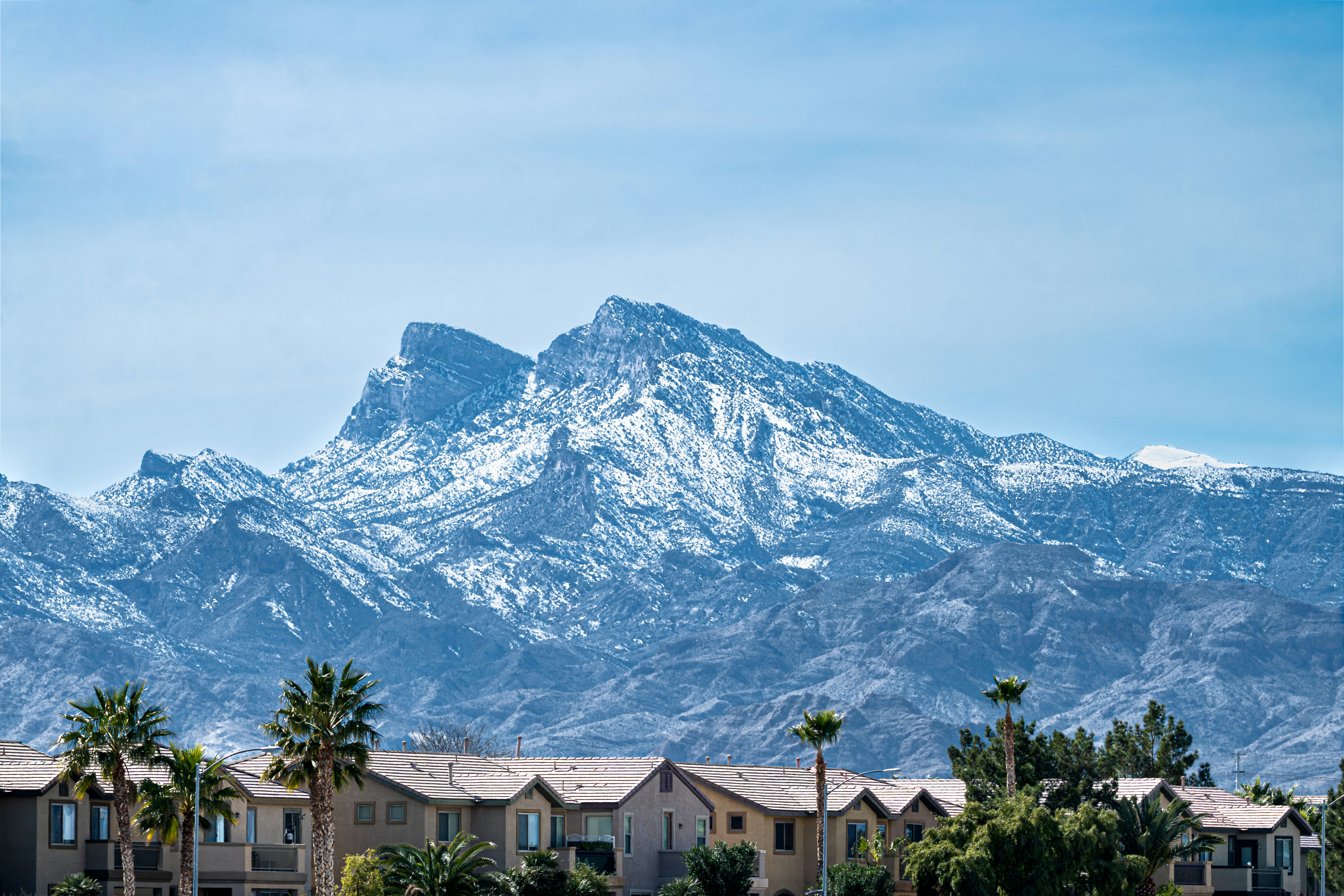 Snow-dusted Peaks Over Suburban Strip