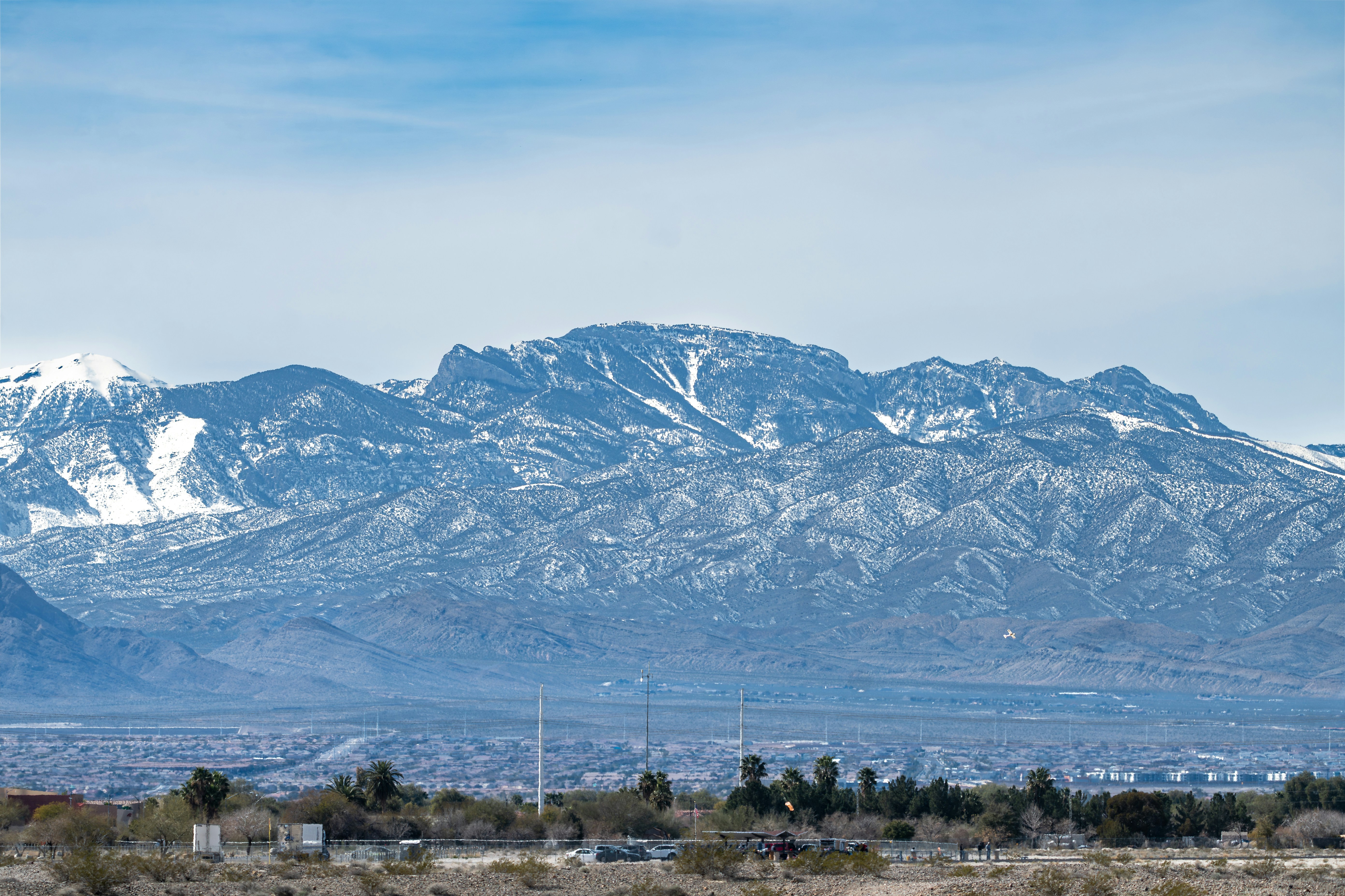 Snow-kissed Peaks Behind a Desert Plain