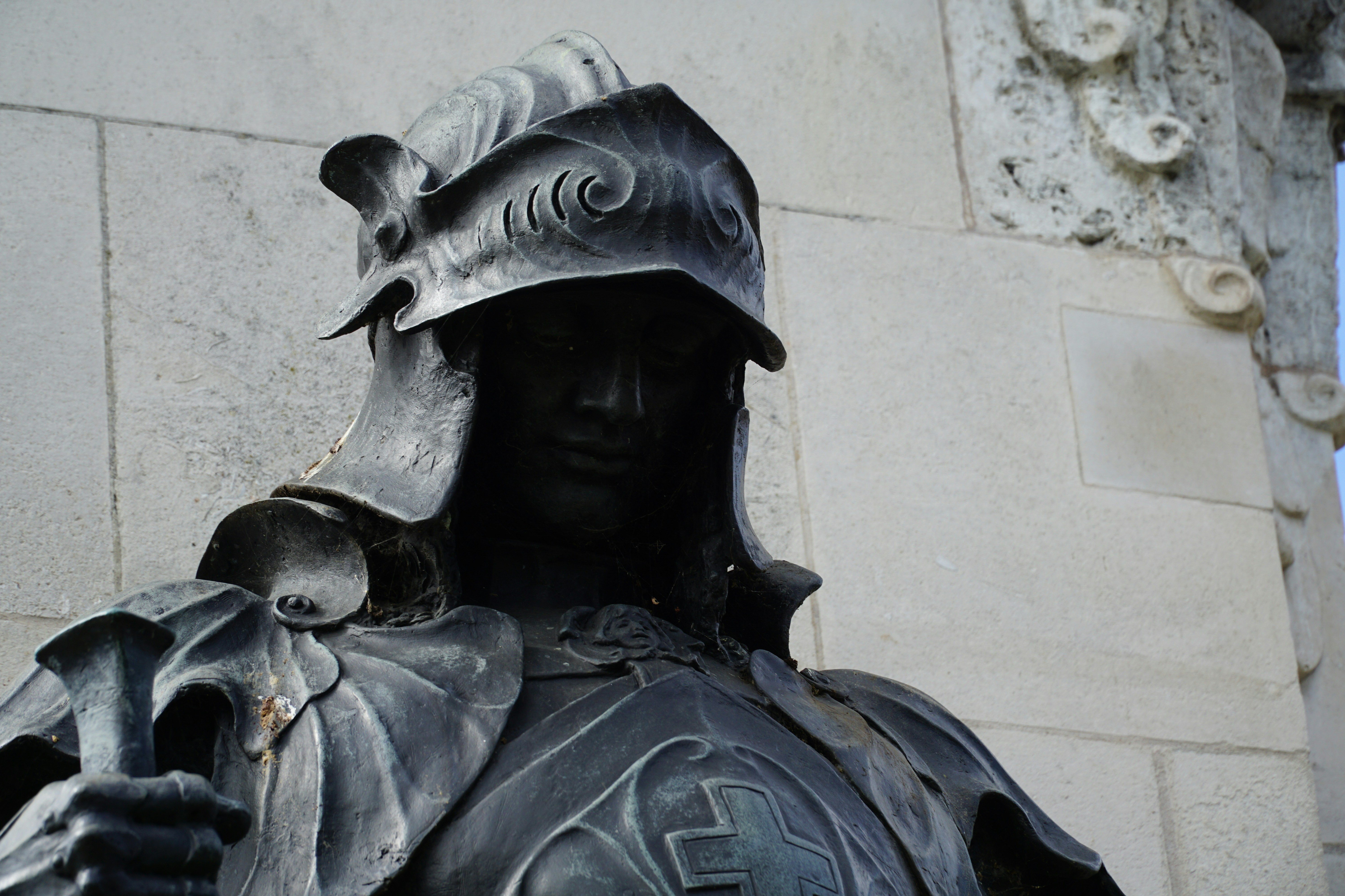 Knight in Weathered Armor Guarding the Stone Facade