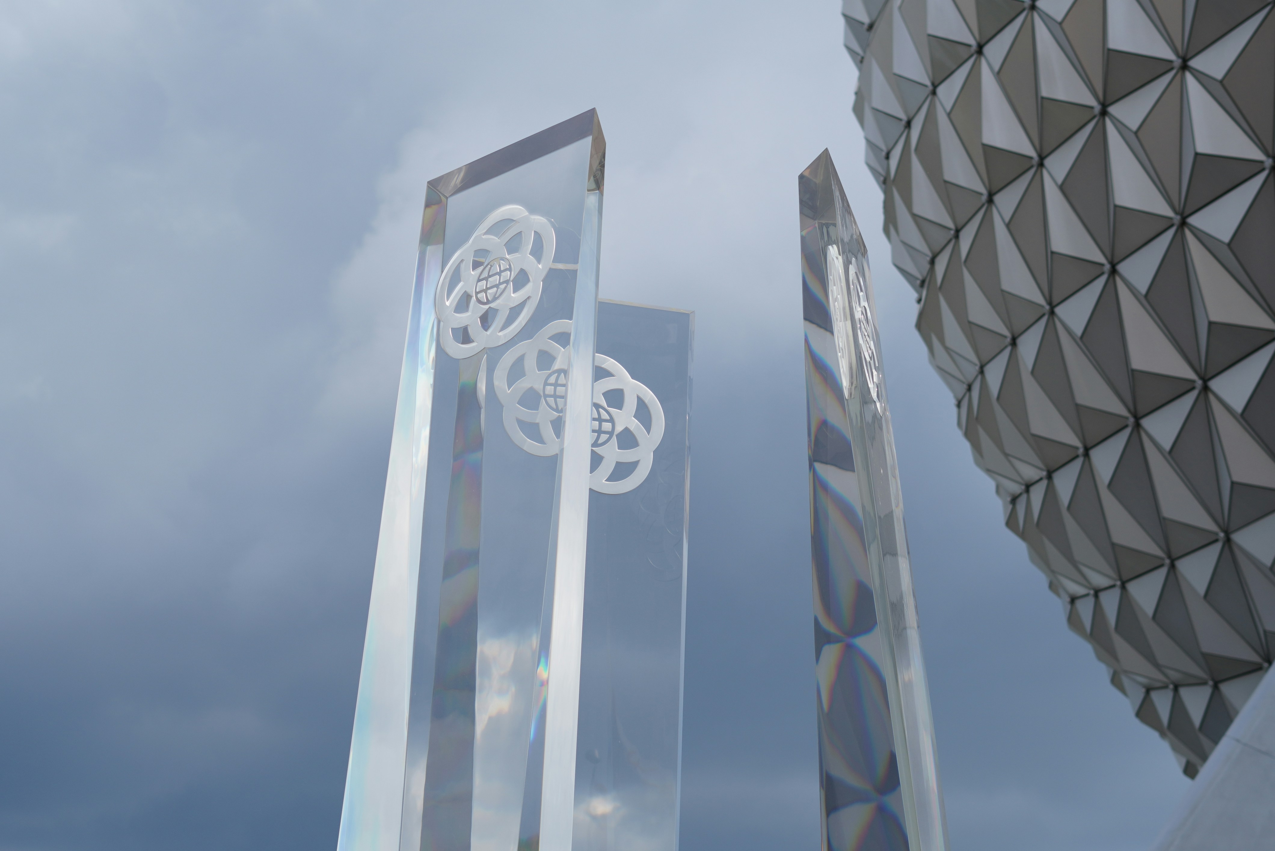 Gleaming pillars under a sculpted sky: abstract metallic towers silhouette